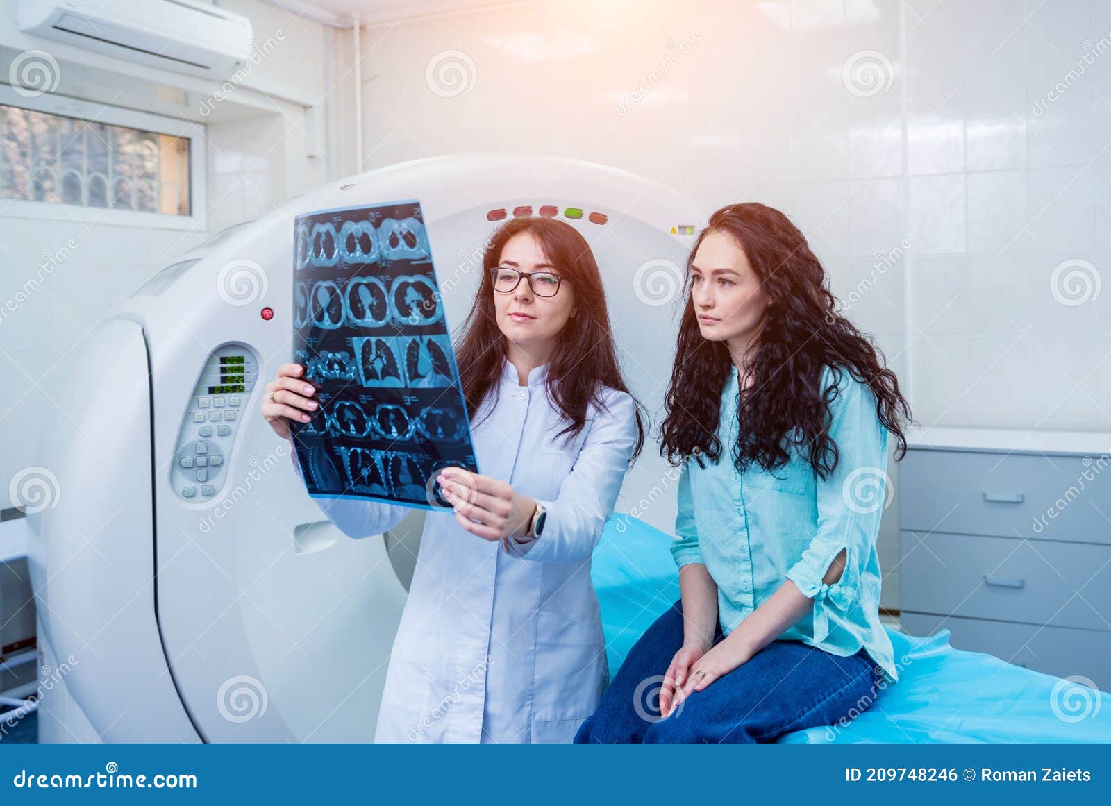 Radiologist with a Female Patient Examining a CT Scan Stock Photo ...