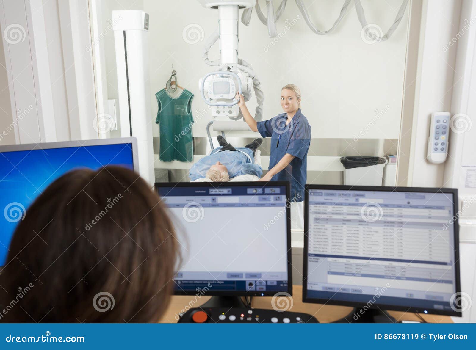 Radiologist Taking Patient`s Xray while Colleague Using Computer Stock ...