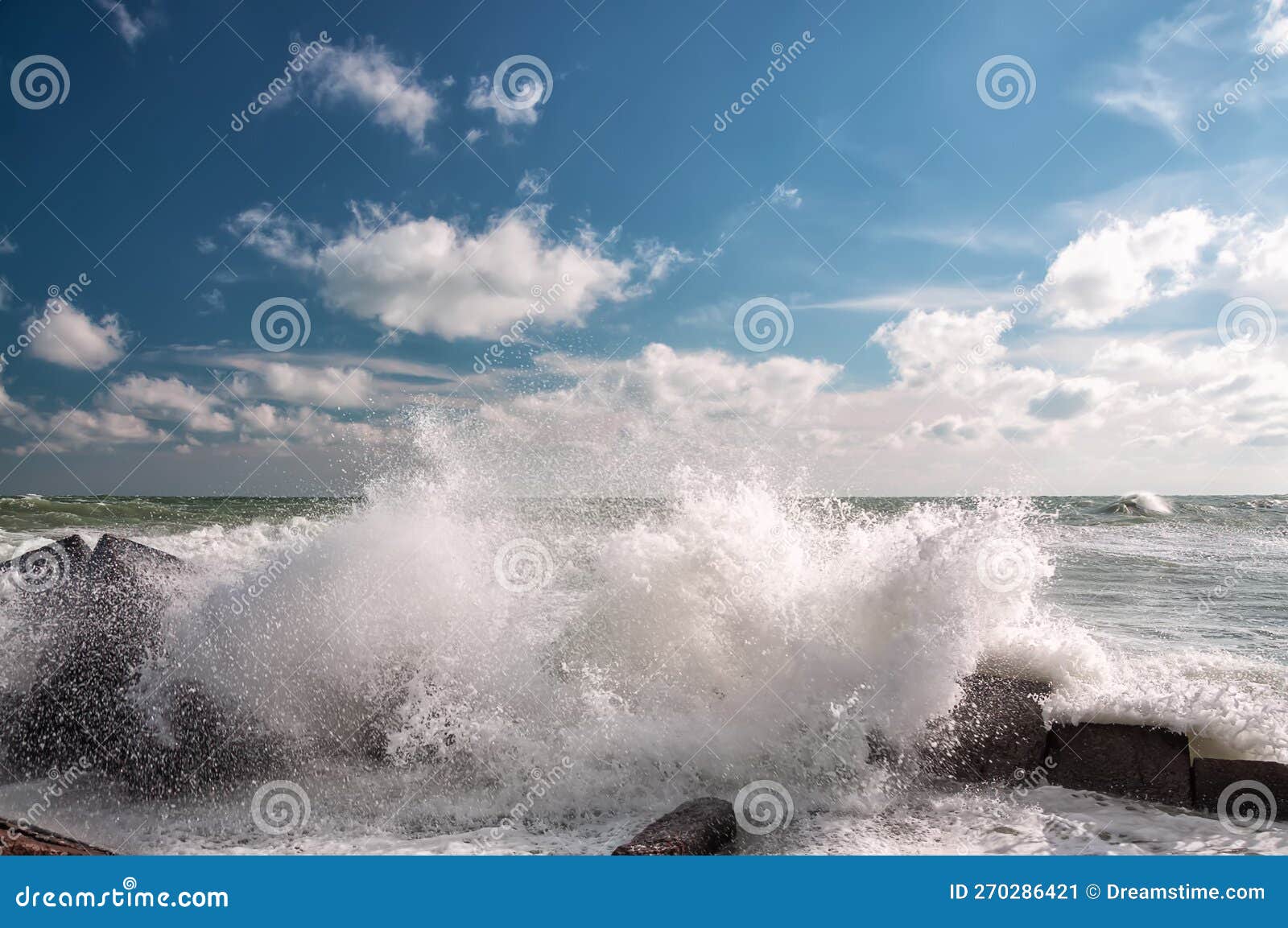 Raging Waves Crash Against Rocky Shore In Storm. Sea Spray And Foam ...