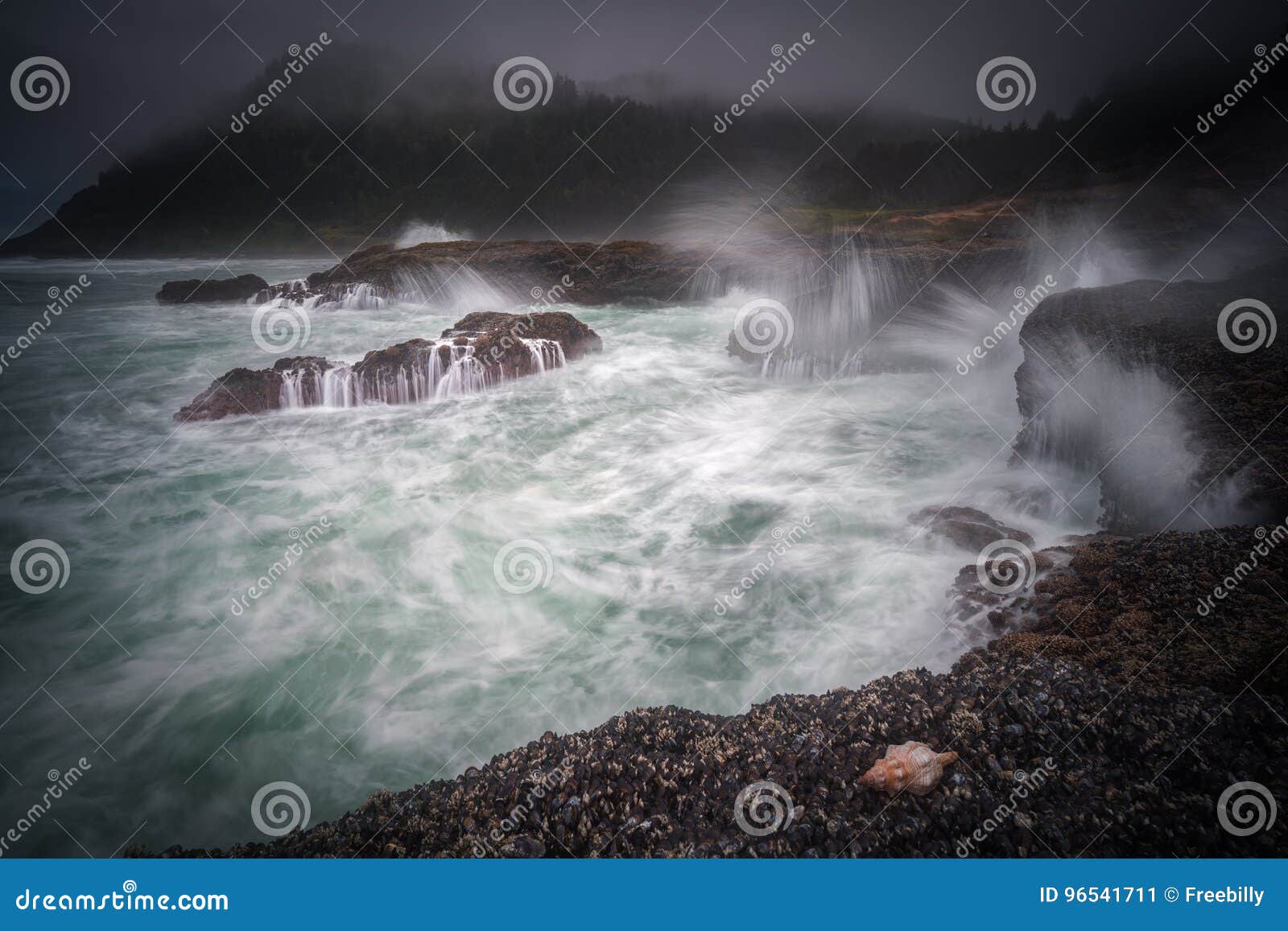 Raging Waves Crash Against Rocky Shore In Storm. Sea Spray And Foam ...