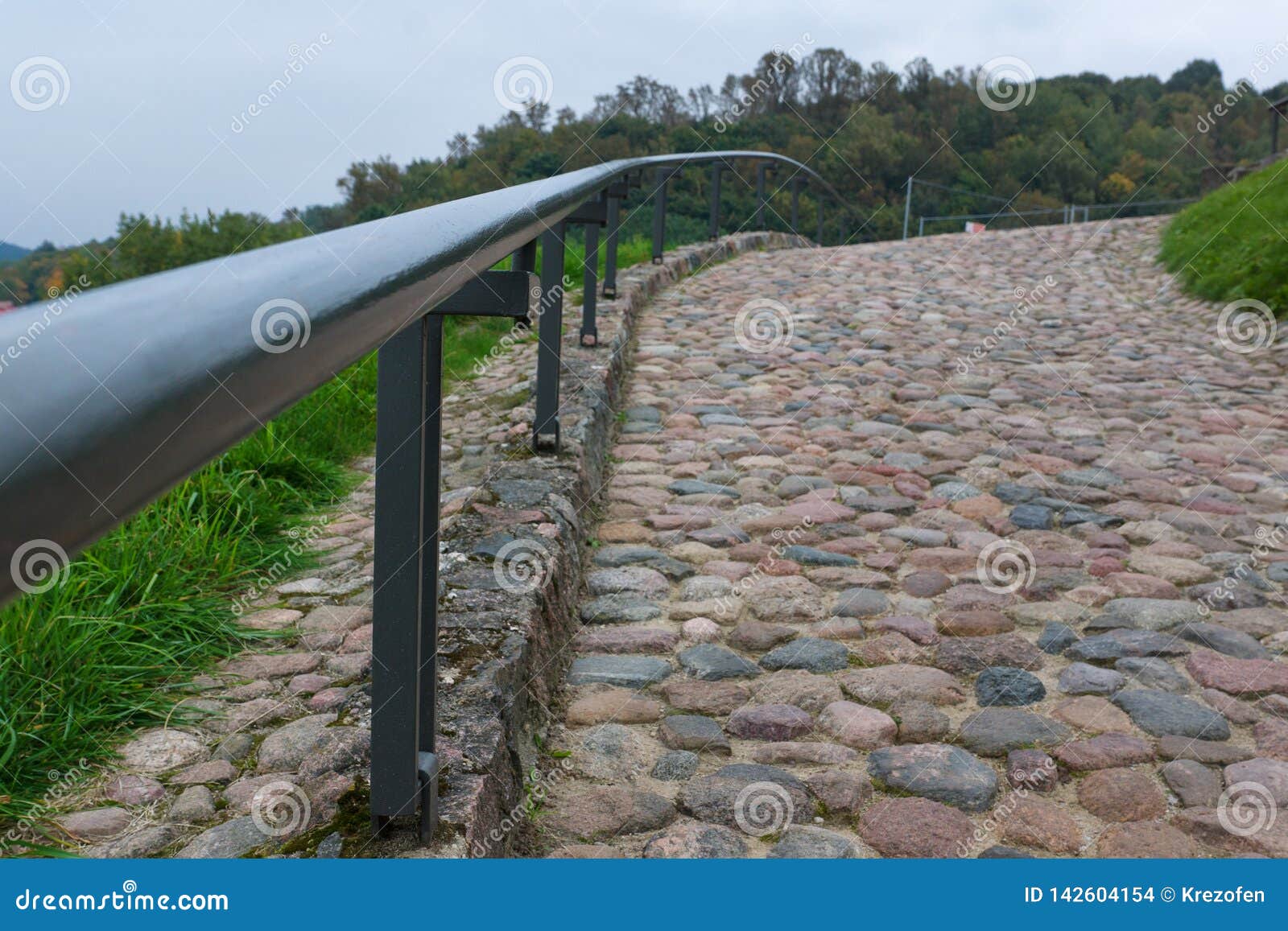 Railings Along the Paved Road Stock Photo - Image of sidewalk, curve ...
