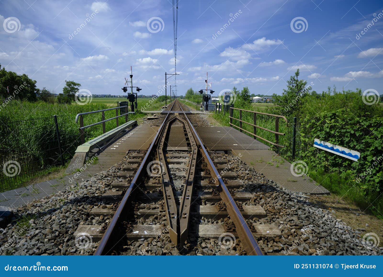 Railroad Crossing between the Meadows in the Netherlands Stock Photo ...