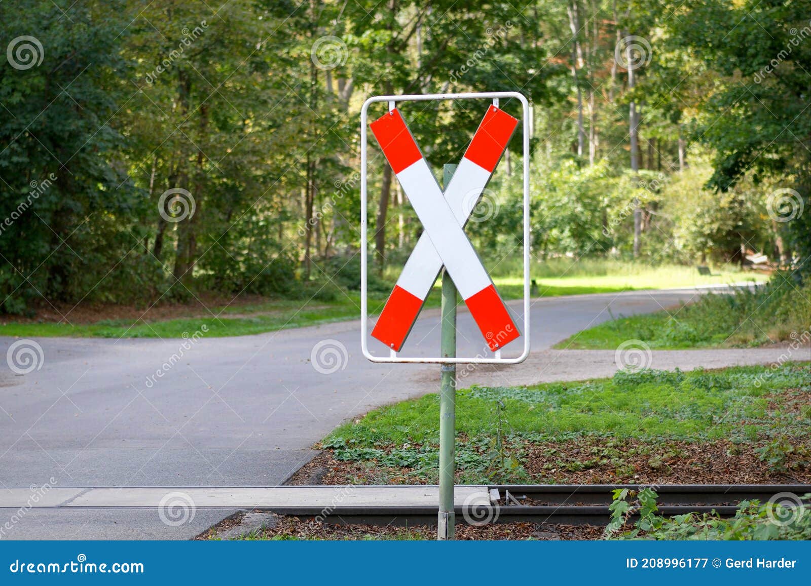 Railroad Crossing Sign in Front of a Railroad Line Stock Image - Image ...