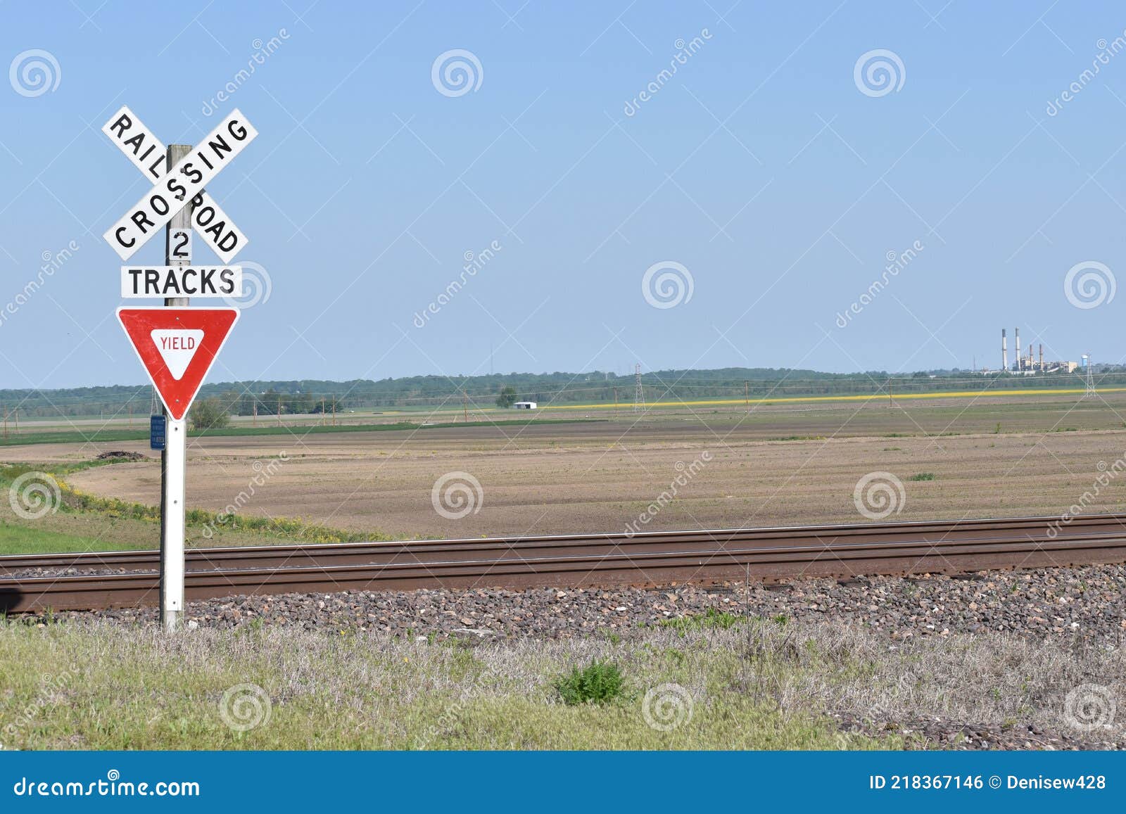 Railroad Crossing Warning Sign in Front of Railroad Tracks in a Rural ...