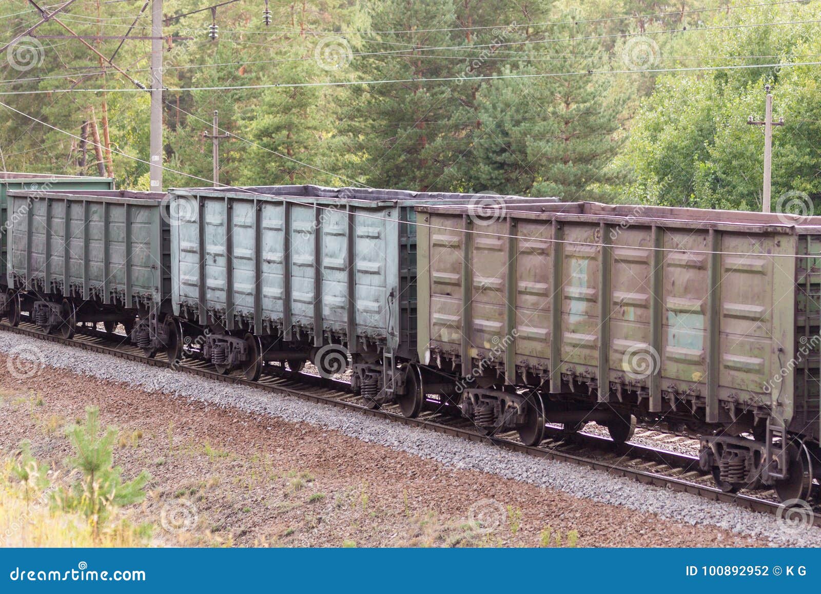 Railroad And Freight Train With Rusty Railway Wagons Going Along Forest ...