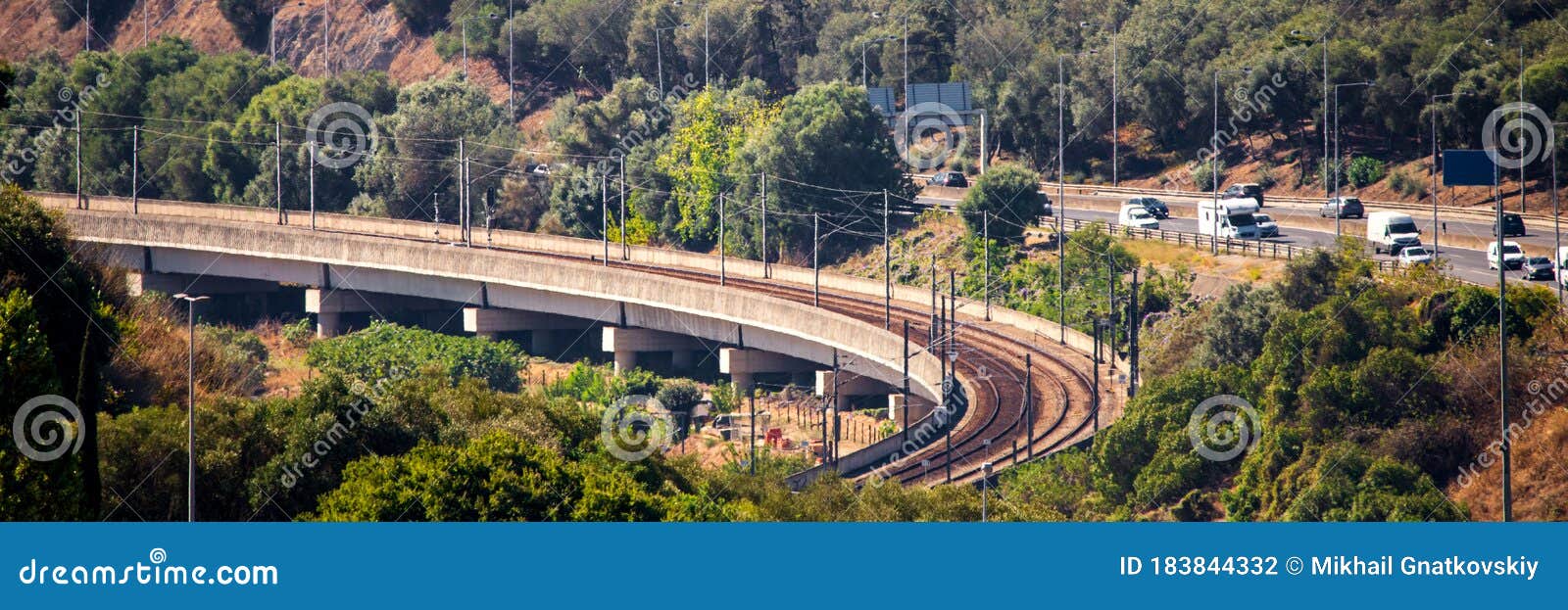 Railroad Track Curve Parallel With Asphalt Road That Cuts A Path ...