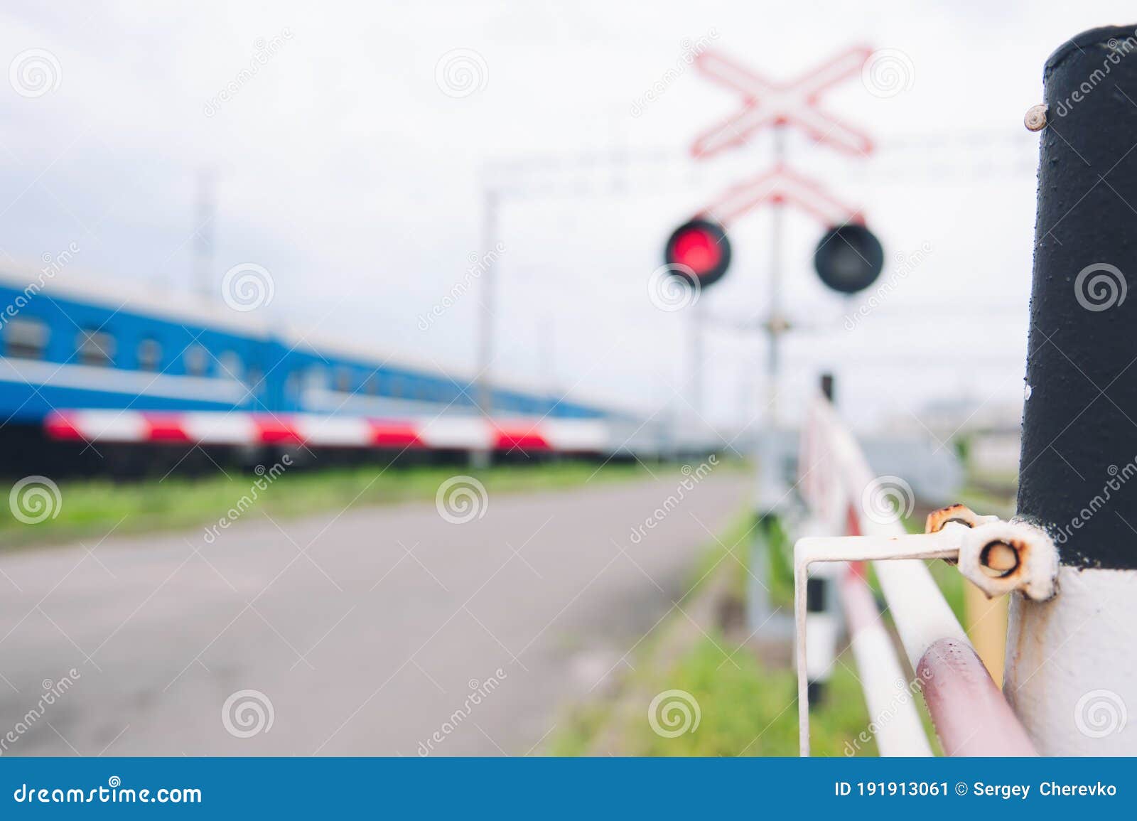 Railway Crossing with a Red Traffic Light on the Background of the ...