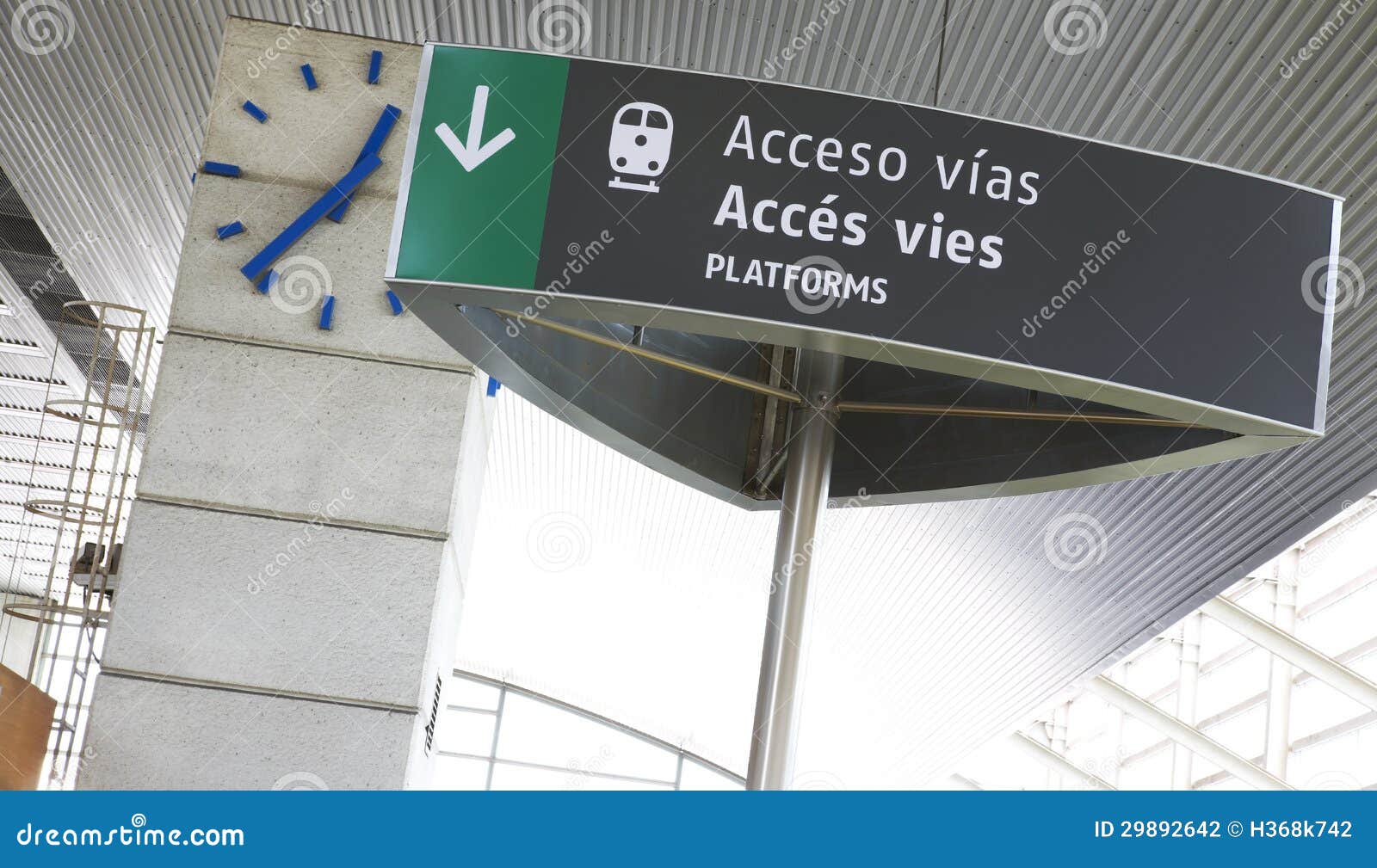 Railway Station with Signpost and Wall Clock Stock Photo - Image of ...