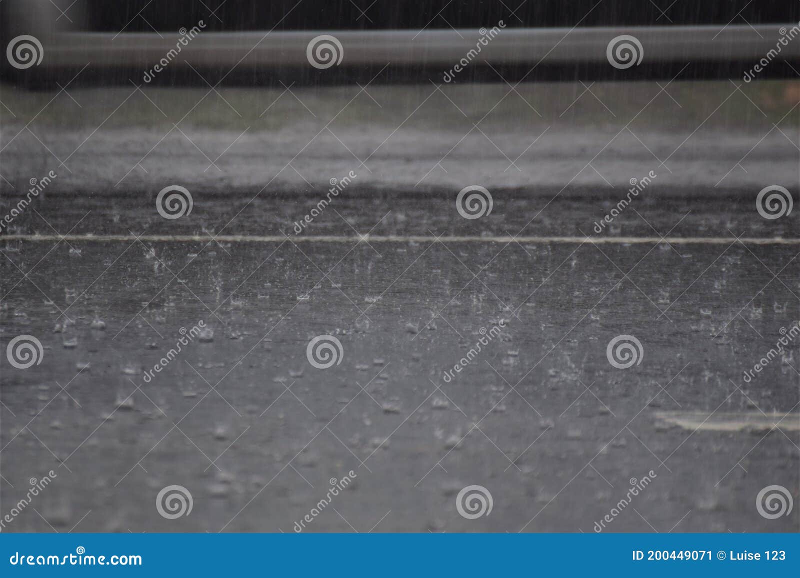 Rain on Dark Grey a Asphalt Road and Some Grass by the Roadside Stock ...