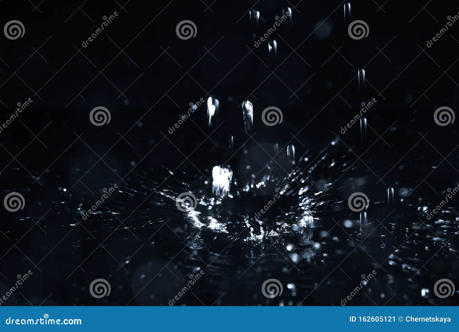 Rain Drops Falling Down into Puddle on Background Stock Image - Image ...