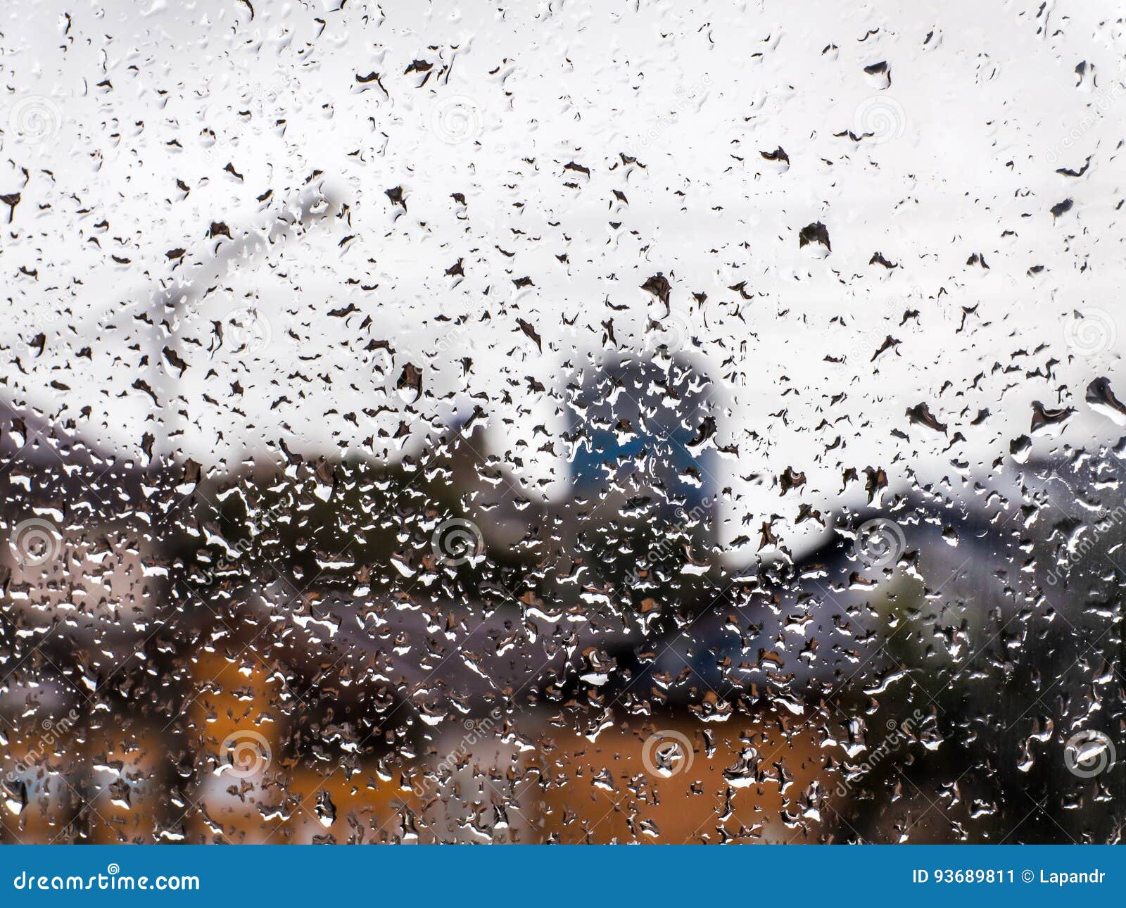 Rain Drops on Glass Window. the Cityscape Outside the Window in a Blur ...