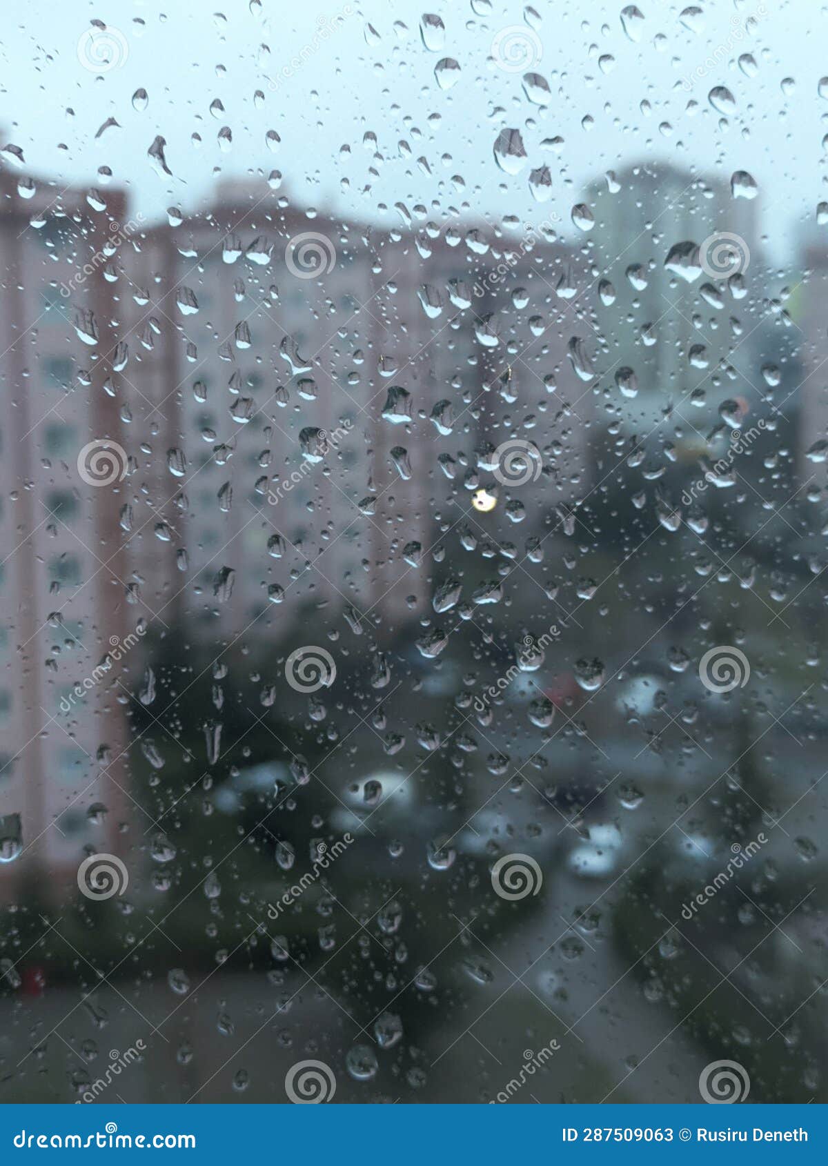 Rain Drops on the Window Glass, Buildings in Background Stock Image ...