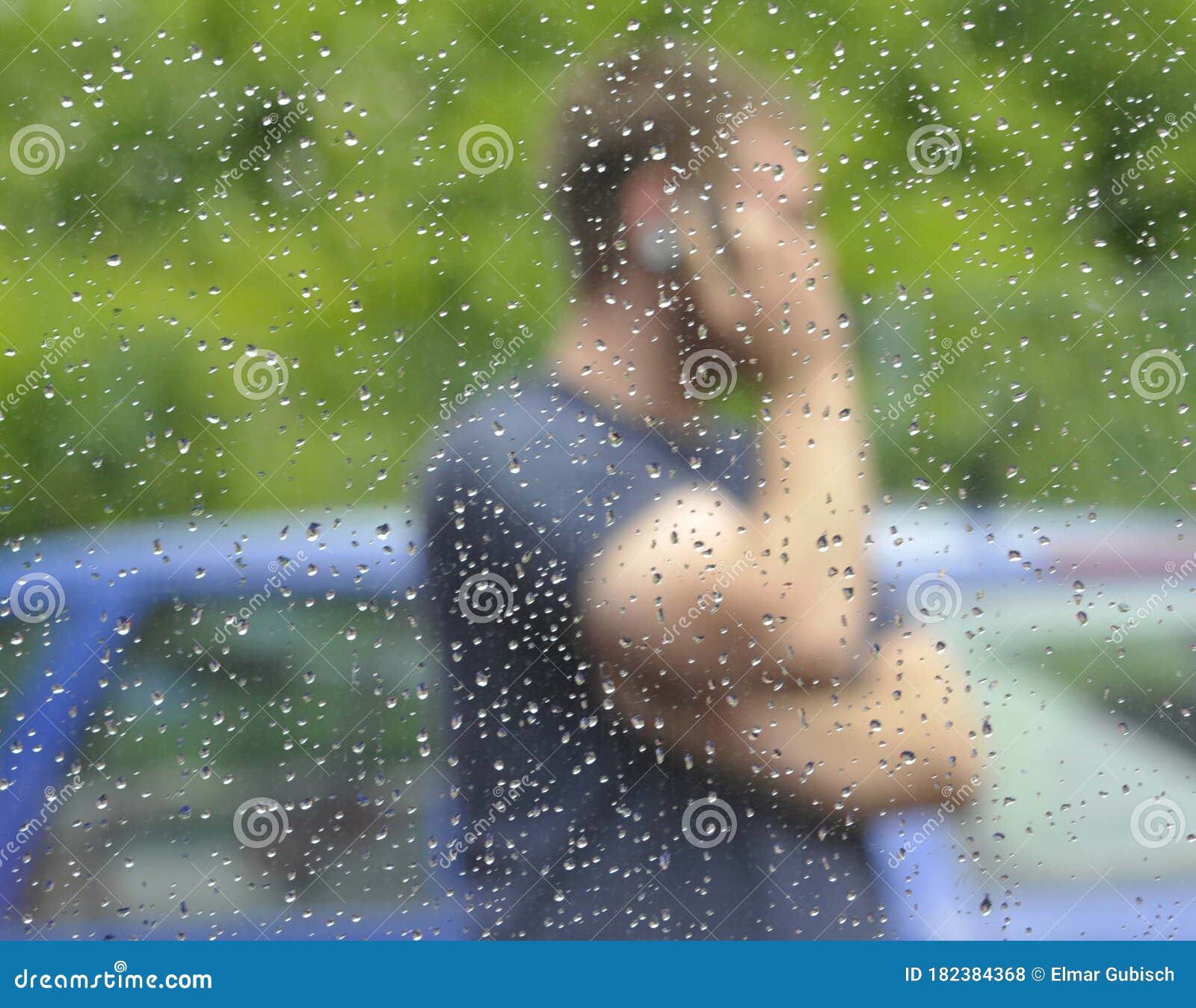 Rain Drops on a Window and Person Making a Phone Call Stock Photo ...