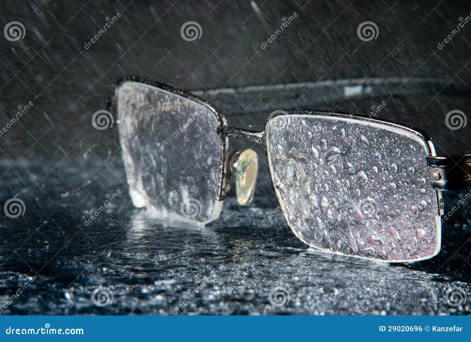 Rain and Glasses Lying on a Mirror Surface with Water Drops Stock Photo ...
