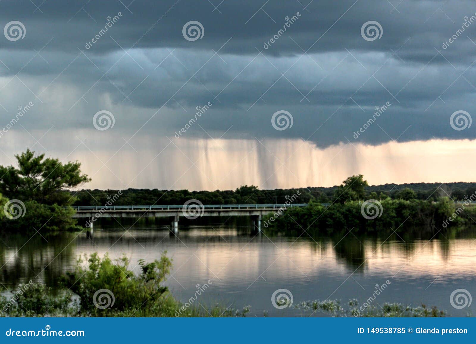 Rain over the bridge stock image. Image of clouds, lake - 149538785