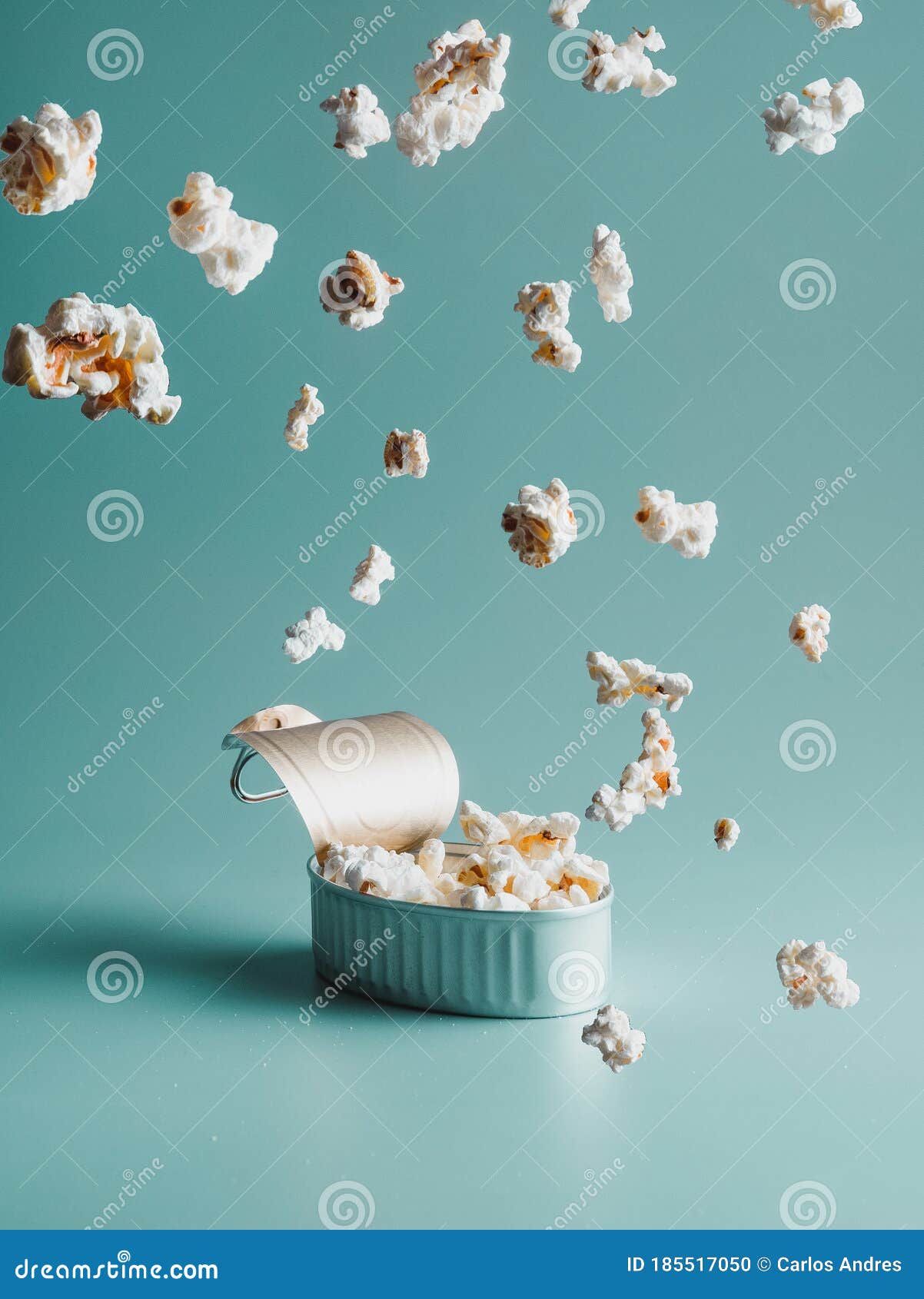 Rain of Popcorn Falling Inside a Can or Tin, Isolated on Light Green ...