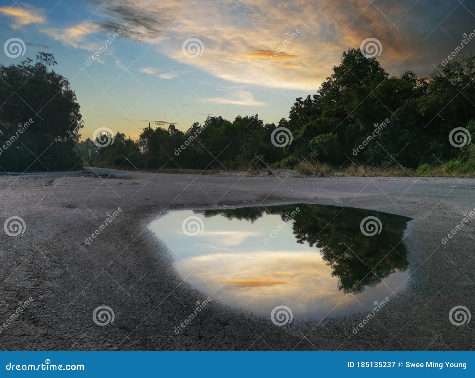 After Rain Puddle by the Road with Sky Reflection on the Surface Stock ...