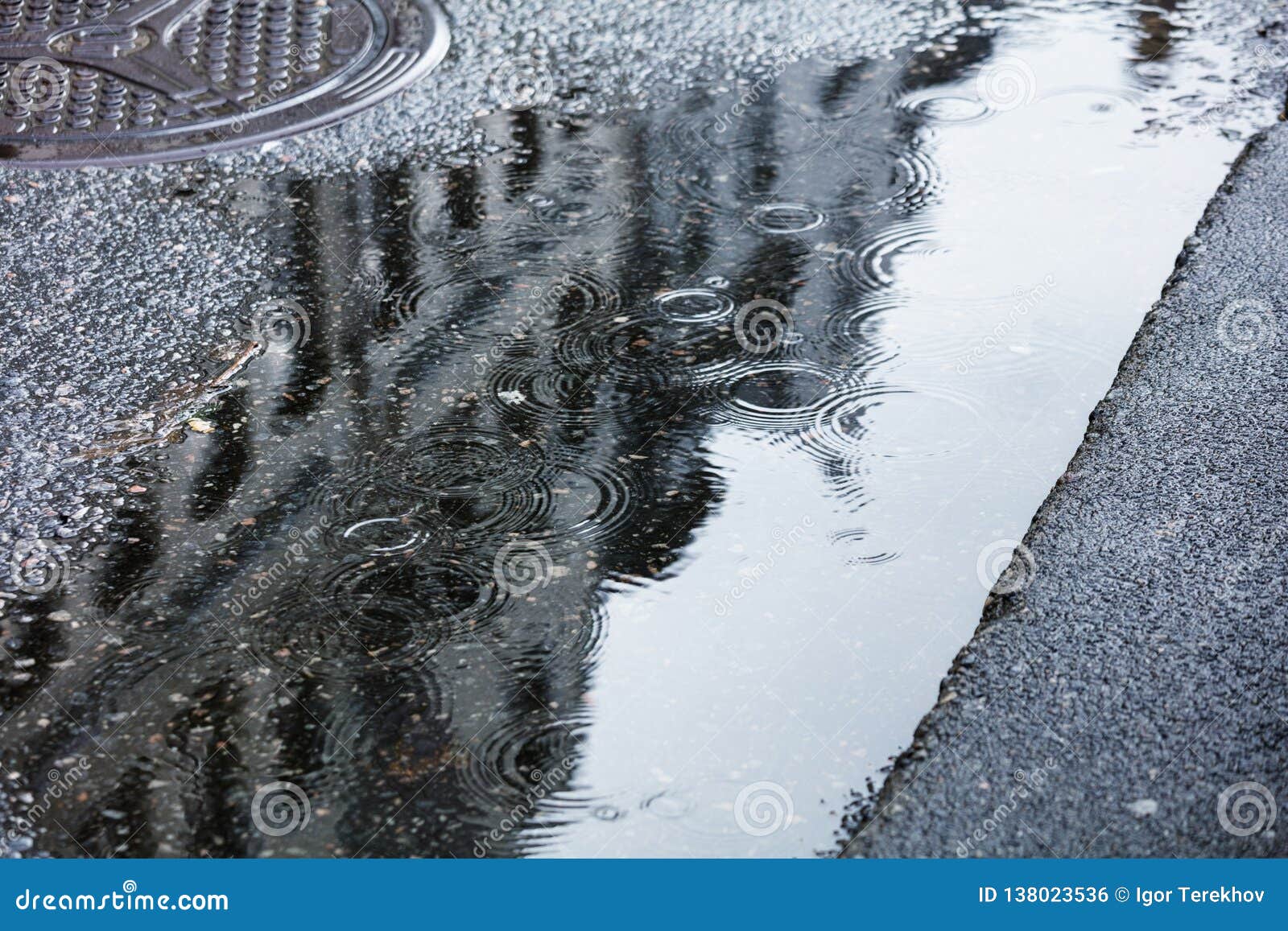 Rain Puddles on Pavement in the City Stock Photo - Image of hatch, rain ...