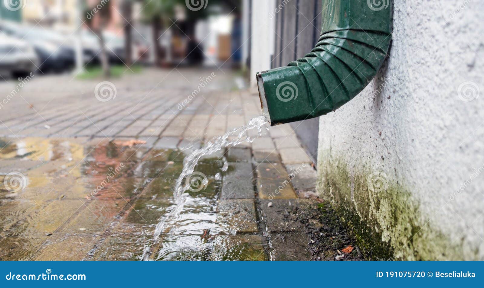 Rain Water is Pouring from the Draining Gutter on the Pavement Stock ...