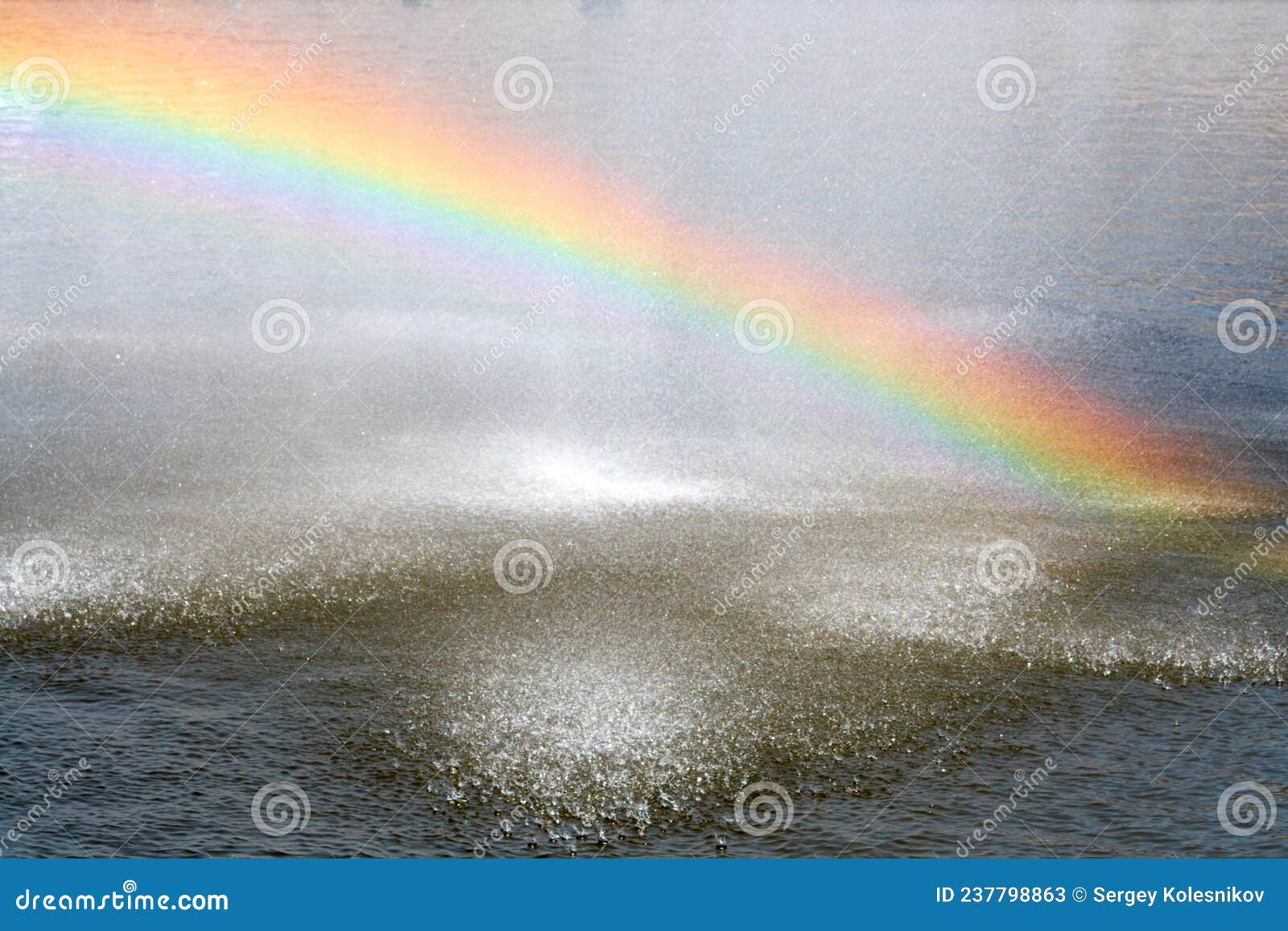 Rainbow Above Water Surface. Rainbow from City Fountain Splash Water ...