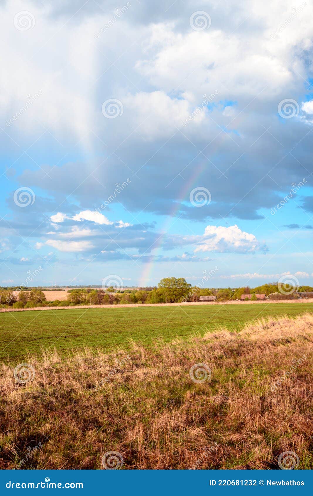 Rainbow Against the Blue Sky with Clouds after a Spring Rain. the ...