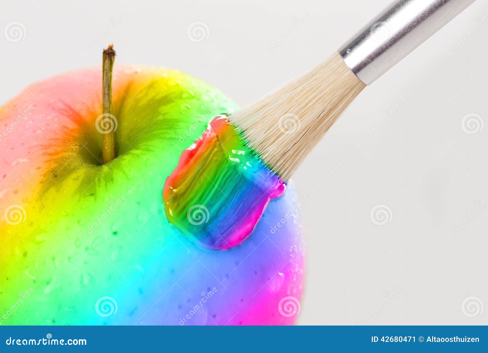 Rainbow Apple Close-up with Water Drops Being Painted on a White Stock ...