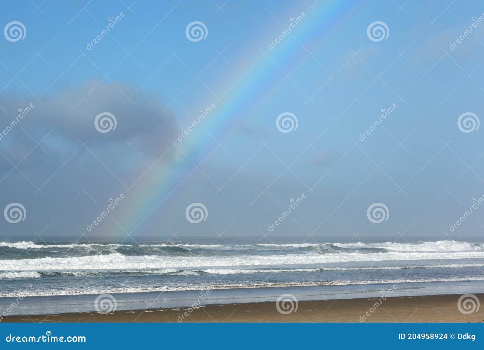 Rainbow at the beach stock photo. Image of blue, ocean - 204958924