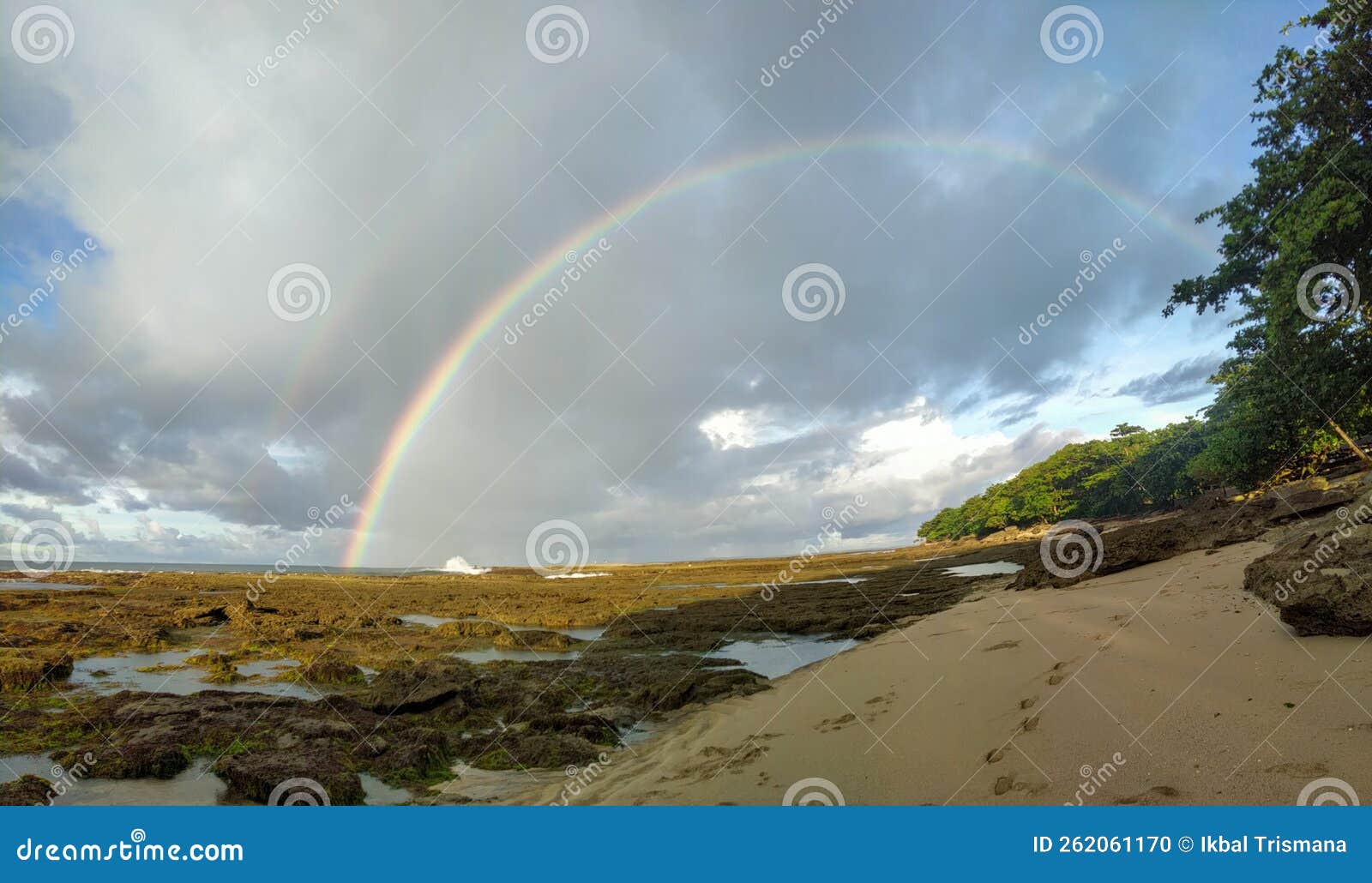 Rainbow on the beach stock photo. Image of wind, morning - 262061170