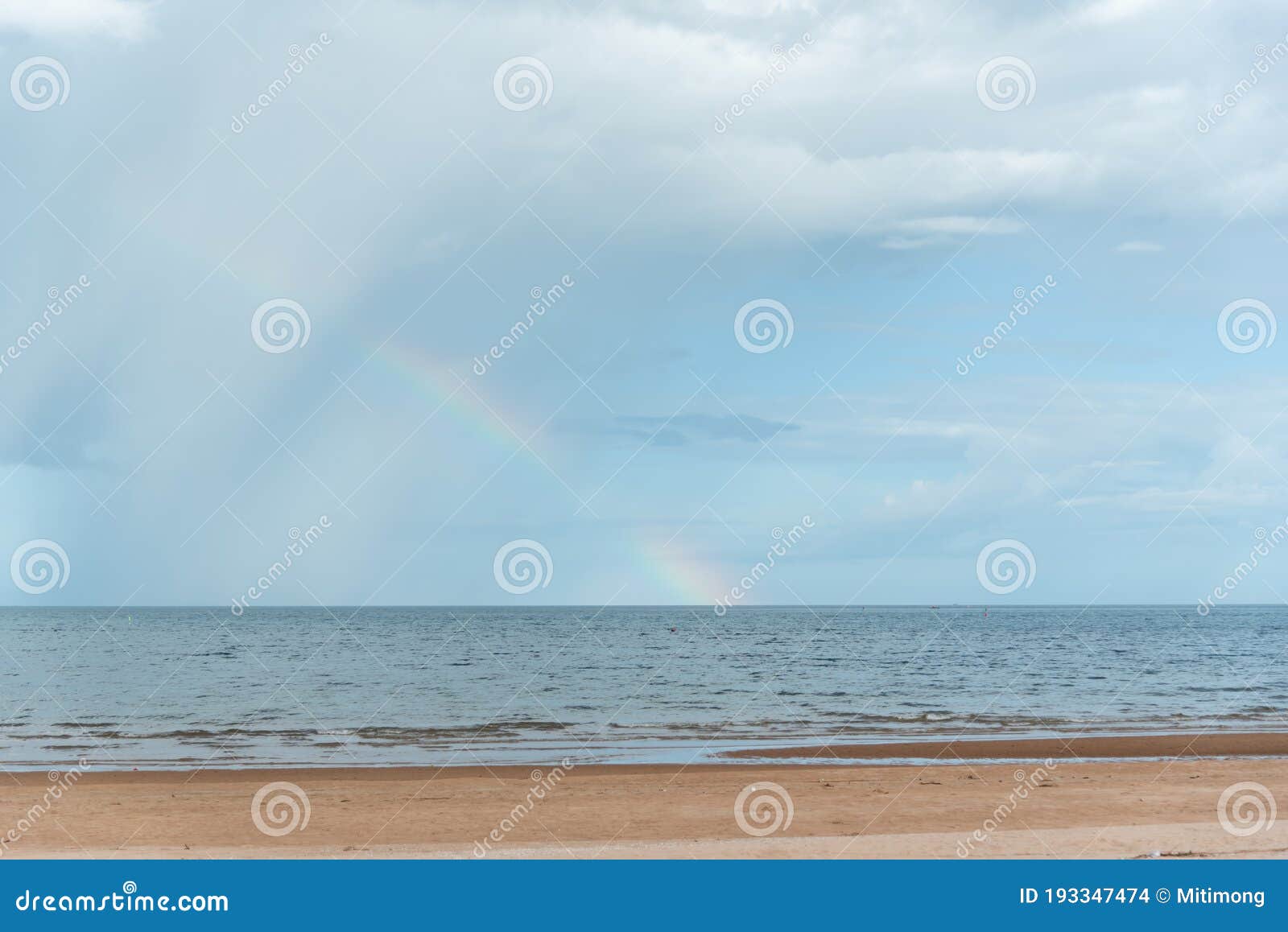 Rainbow over the sea stock photo. Image of water, landscape - 193347474