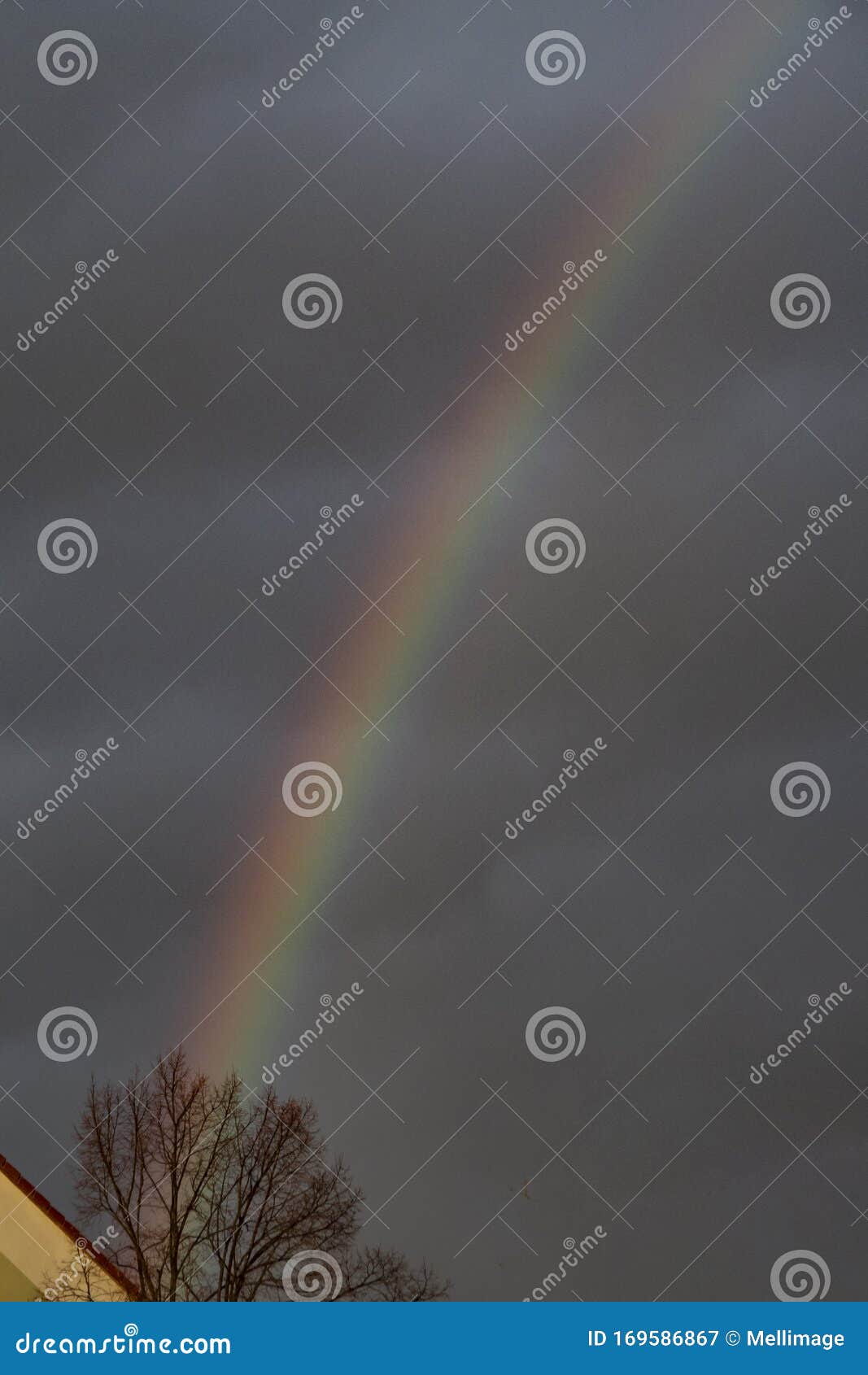Rainbow in a cloudy sky stock image. Image of natural - 169586867