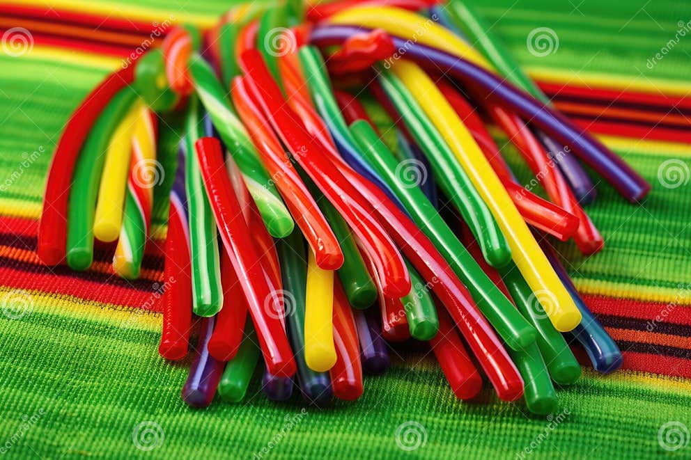 Rainbow-colored Candy Canes on a Green Mat Stock Illustration ...