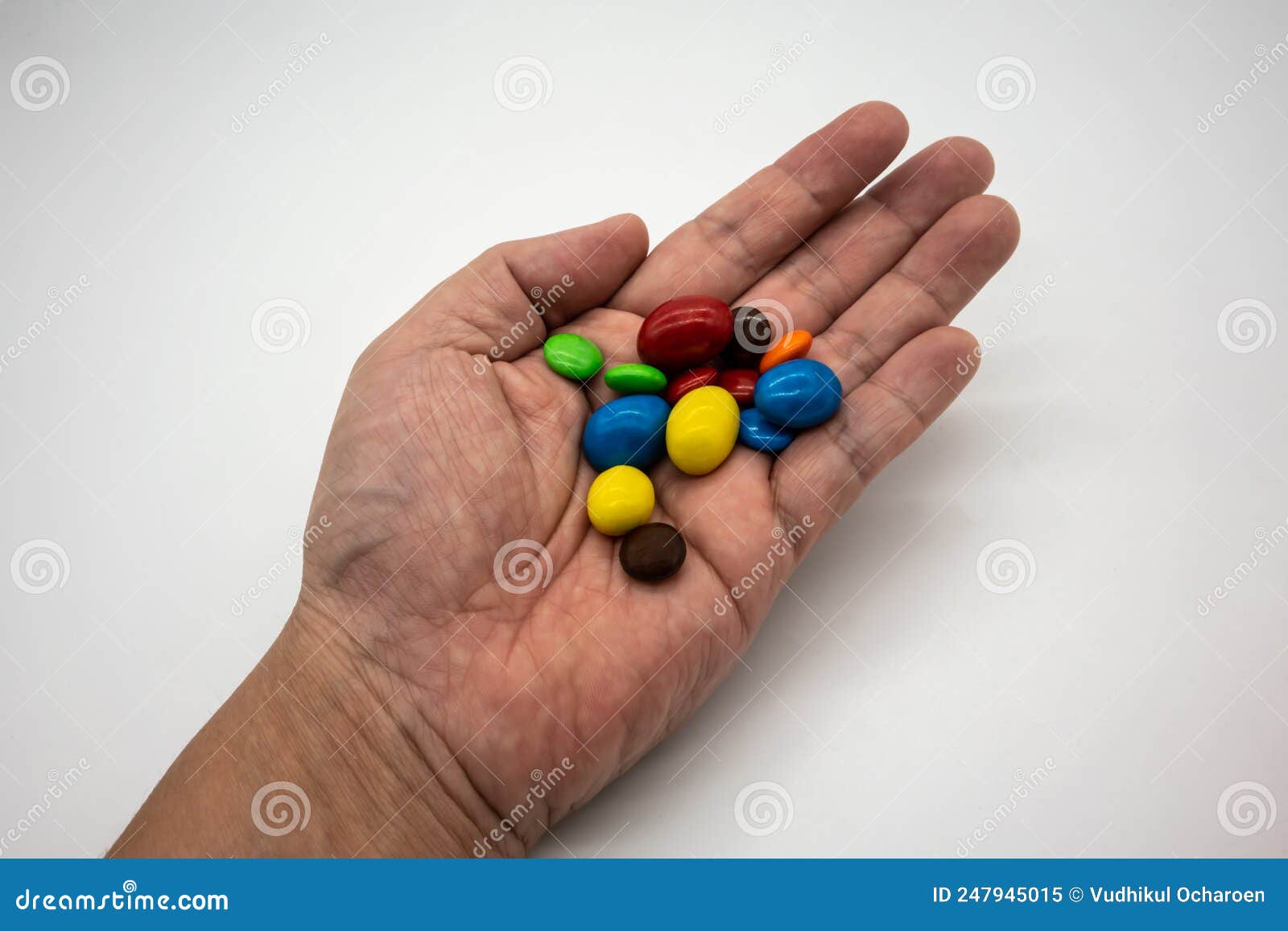 Rainbow Colored Candy Coated Chocolate Buttons in Hand Isolated on ...