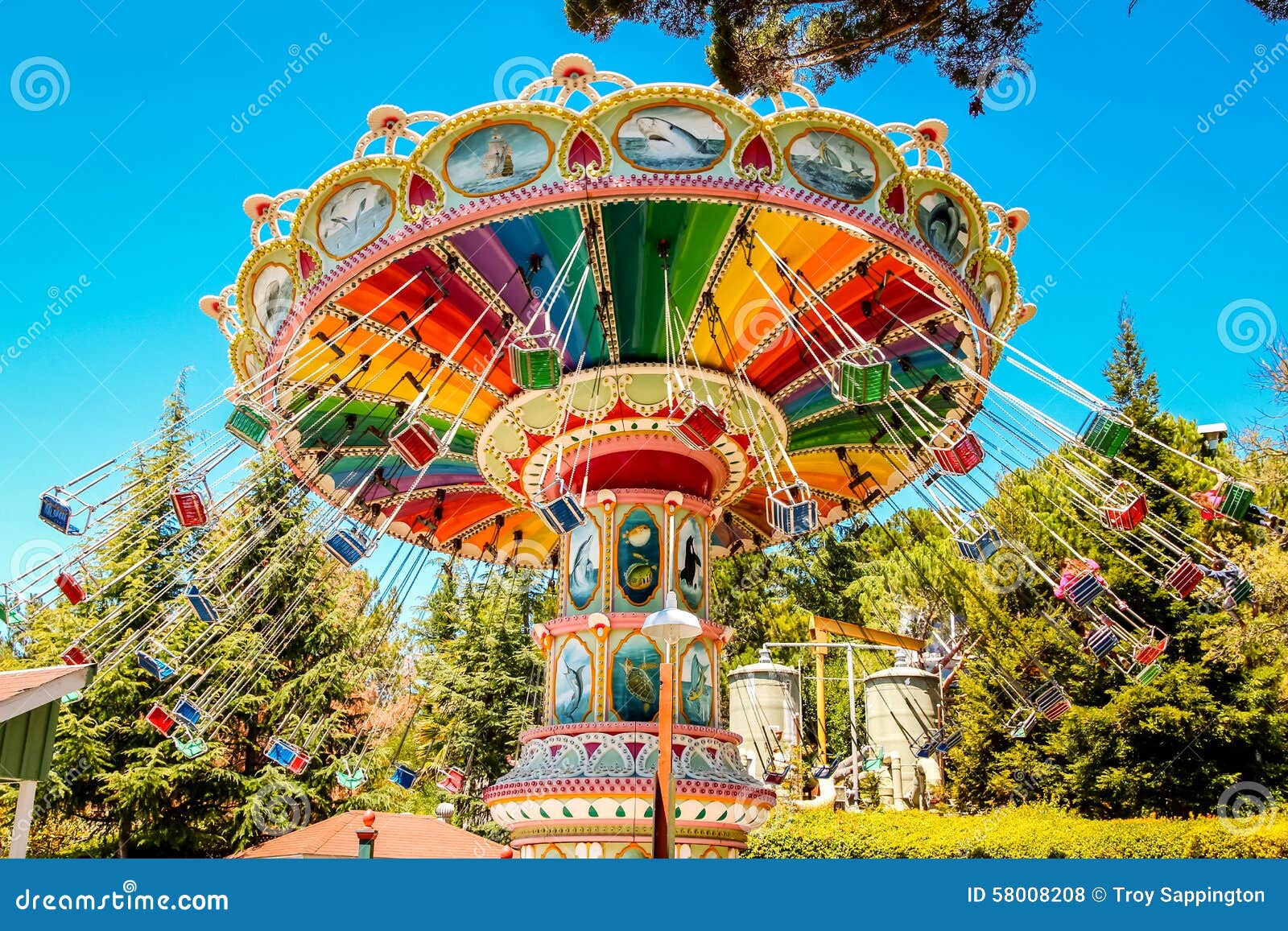 A Rainbow Colored Swing Carousel at an Amusement Park. Stock Photo ...