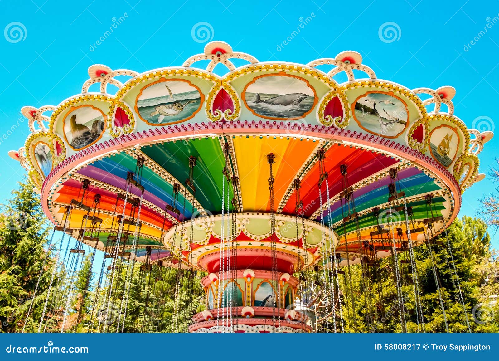A Rainbow Colored Swing Carousel at an Amusement Park. Stock Image ...