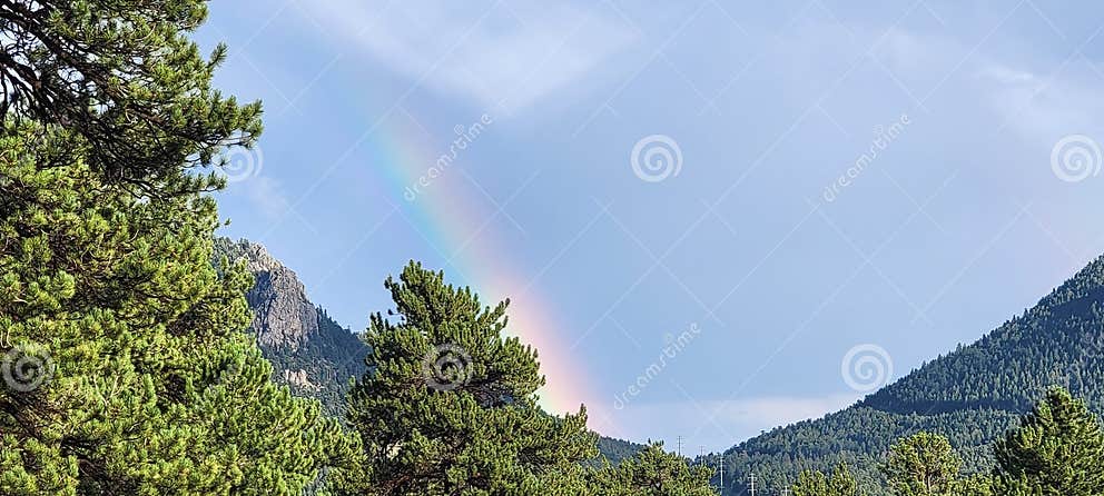 Rainbow Emerging in the Mountains Stock Image - Image of trees ...