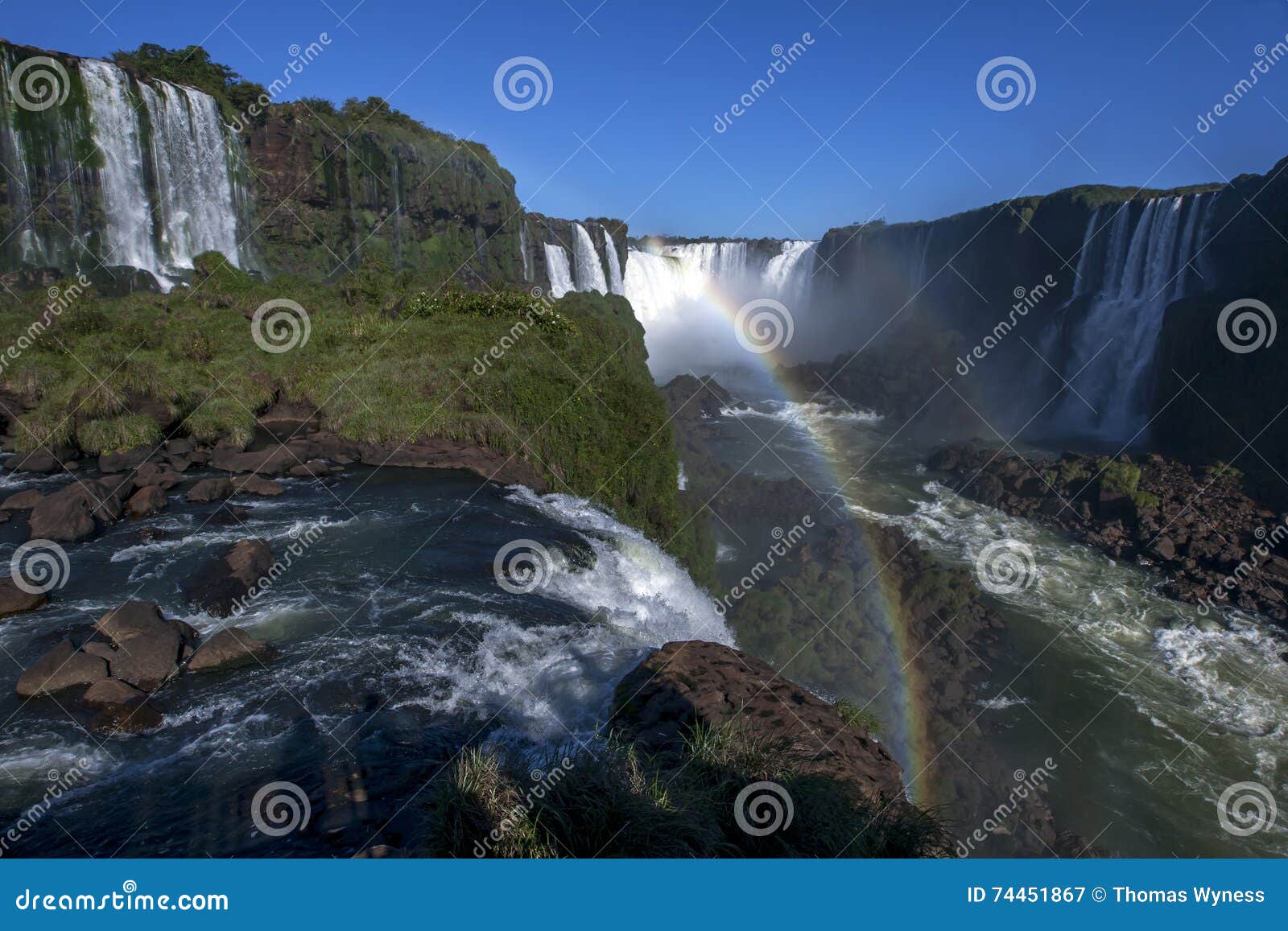 A Rainbow Forms Over the Magnificent Iguazu Falls in Brazil. Stock ...
