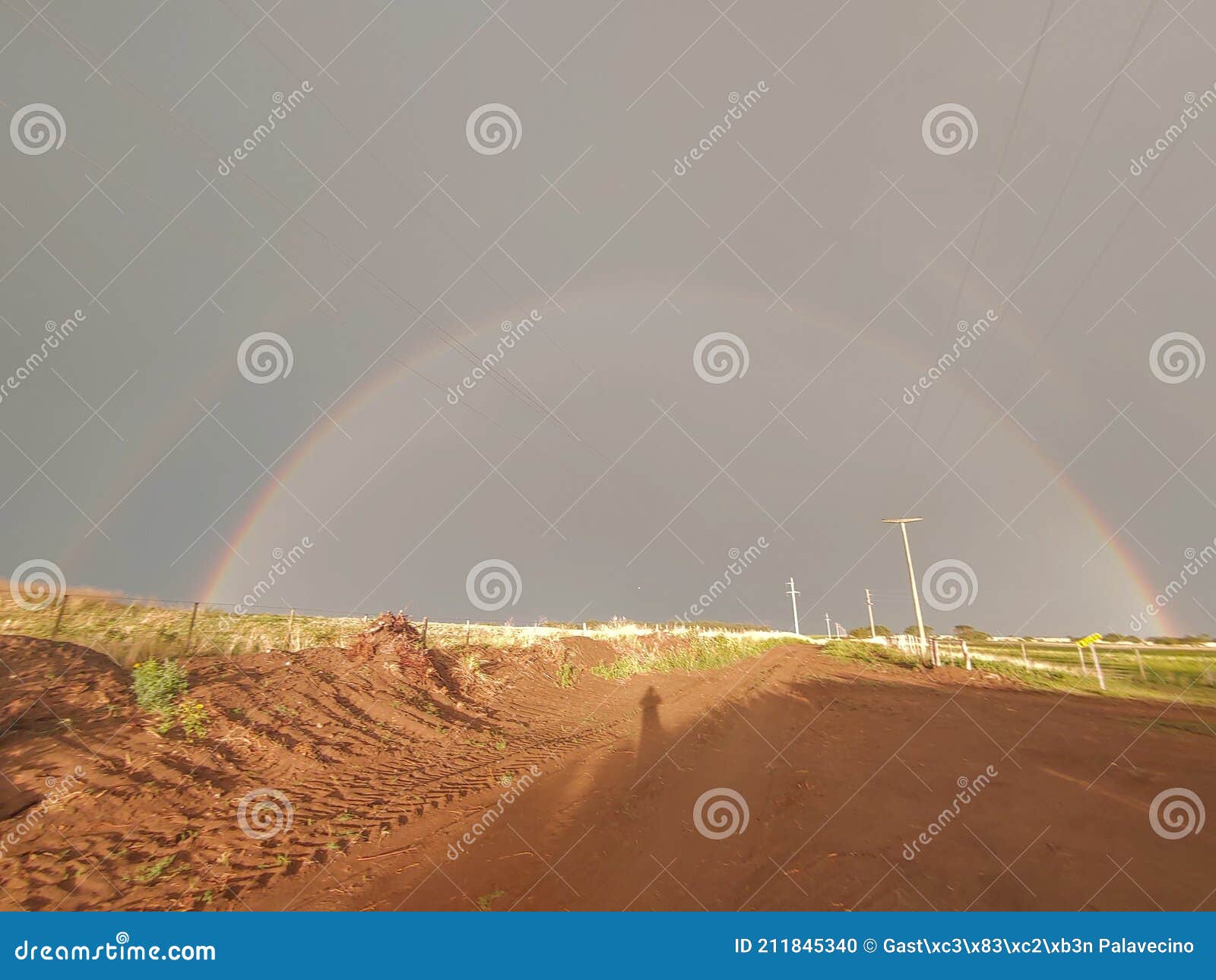 Rainbow Over Country Road after a Rainy Day. Stock Photo - Image of ...
