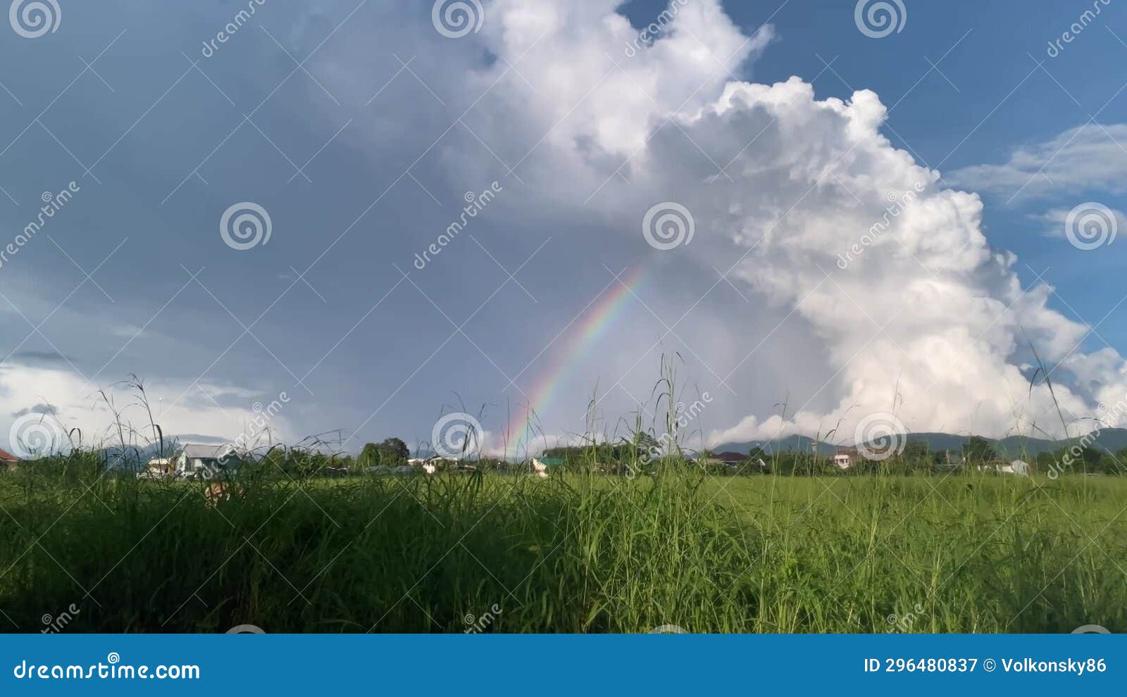 Rainbow Over a Field in the Distance among the Clouds after the Rain ...