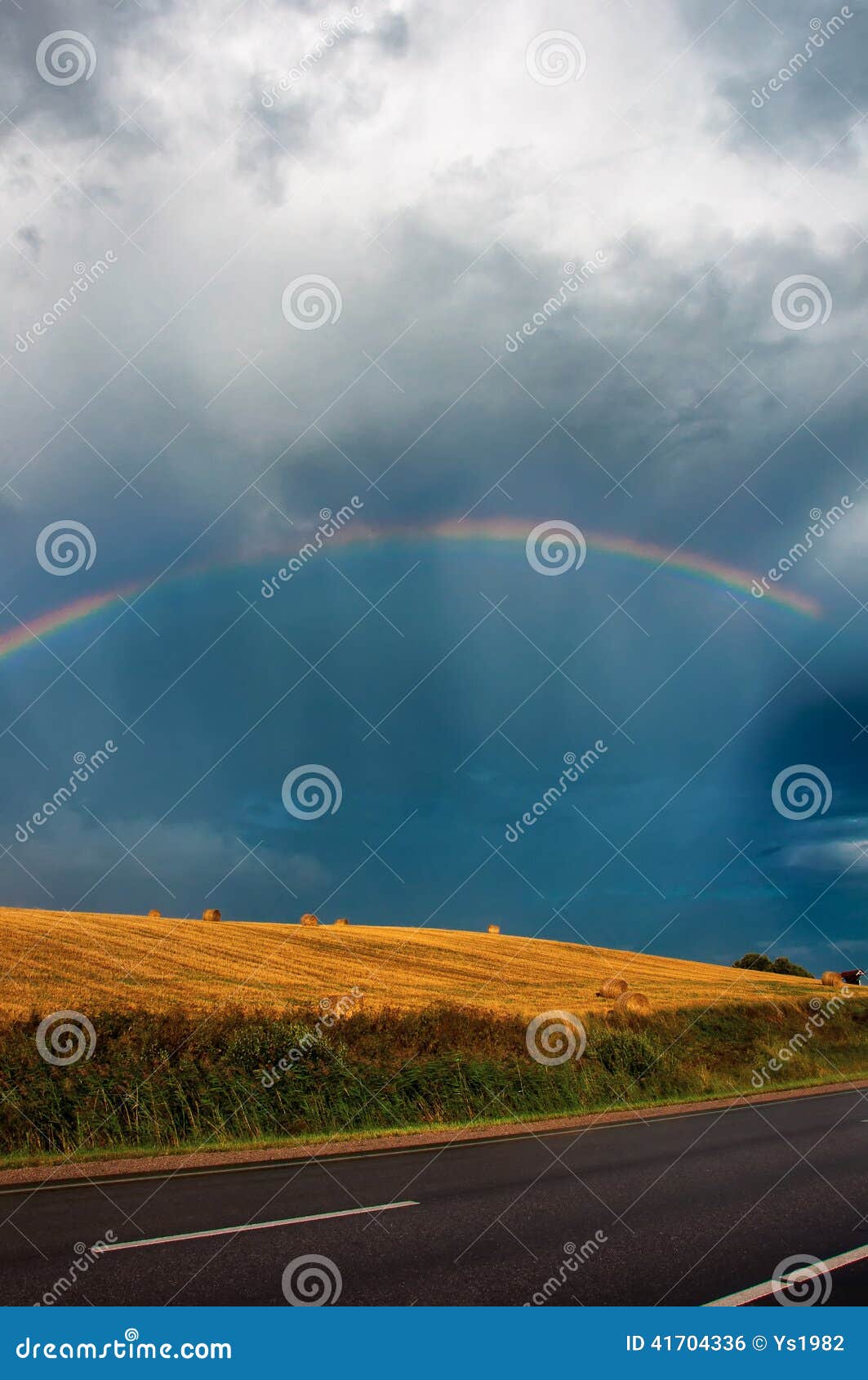 Rainbow over field road stock photo. Image of landscape - 41704336