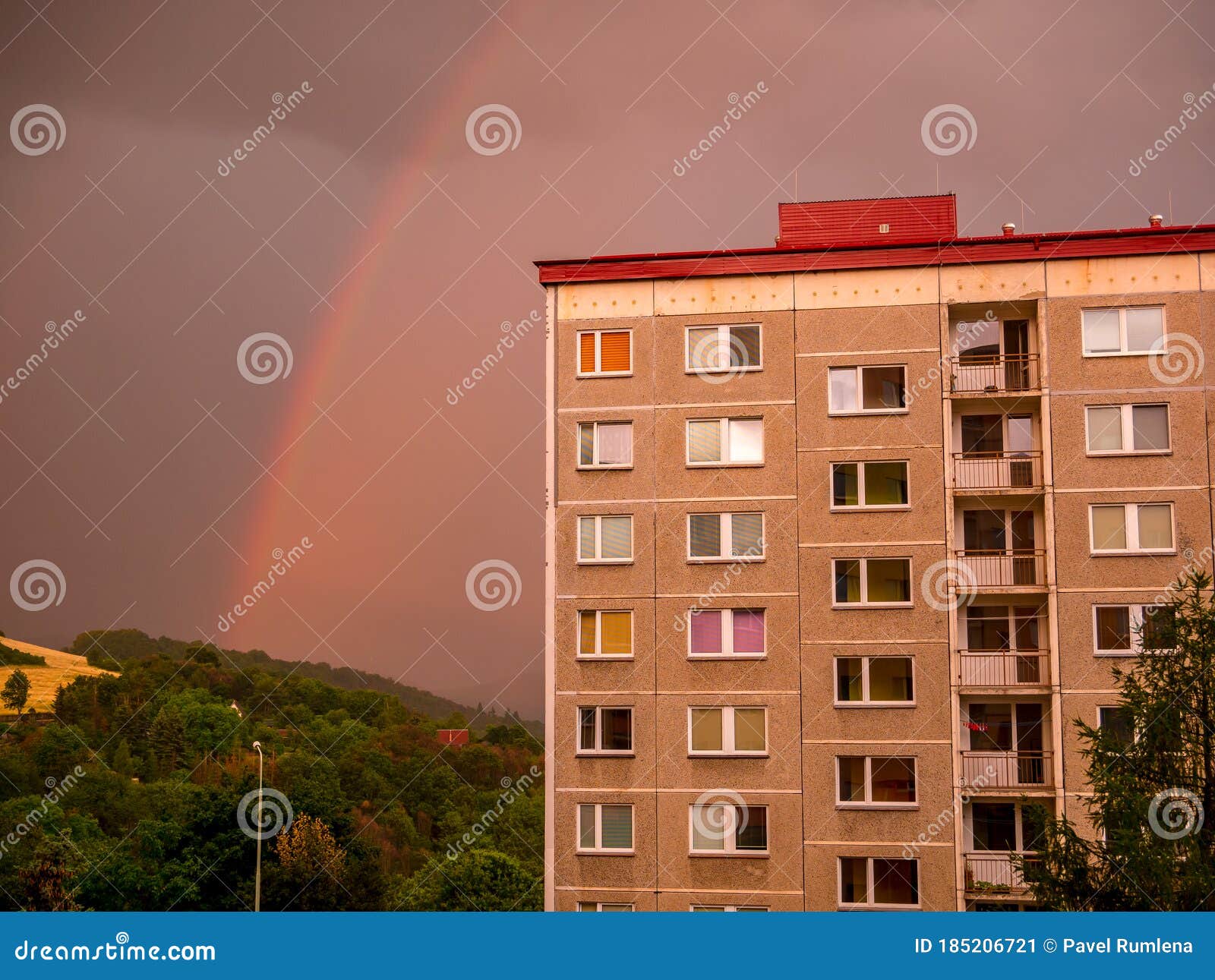 Rainbow Over the House with Dense Rain Clouds in the Background Stock ...