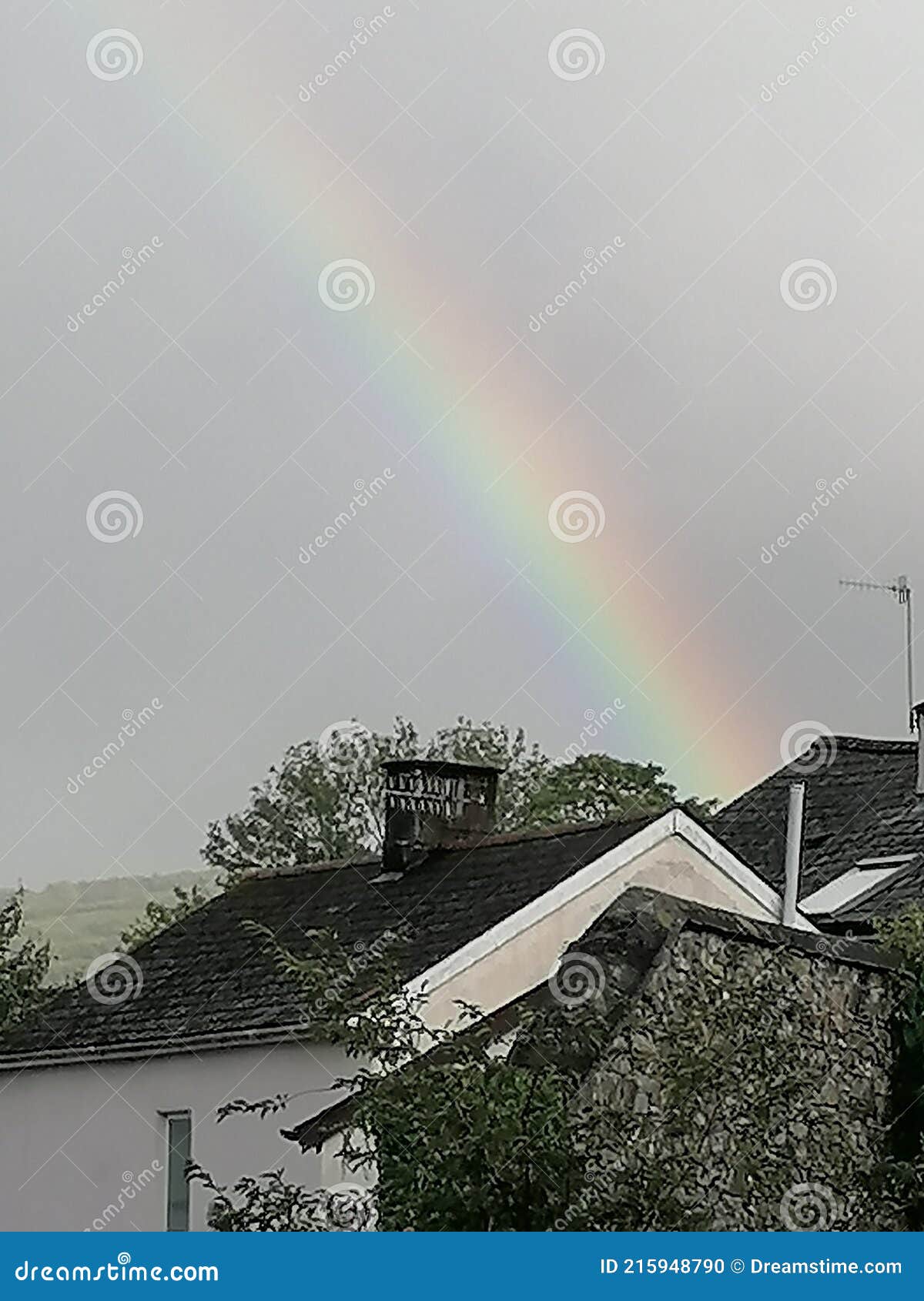 Rainbow over houses stock photo. Image of storm, landmark - 215948790