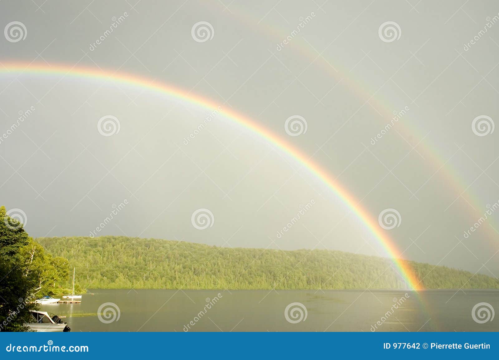 Rainbow over a lake 1 stock photo. Image of colours, rain - 977642
