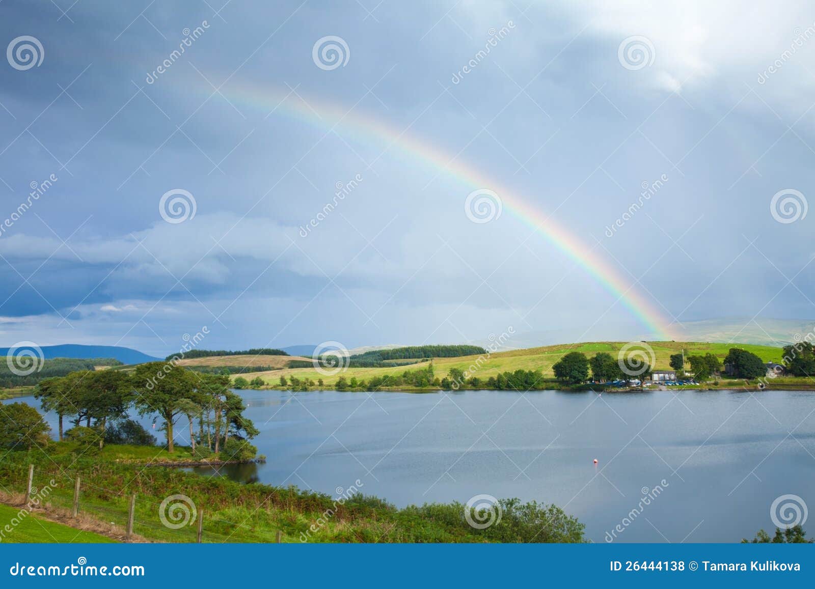 Rainbow over a lake stock photo. Image of rain, light - 26444138