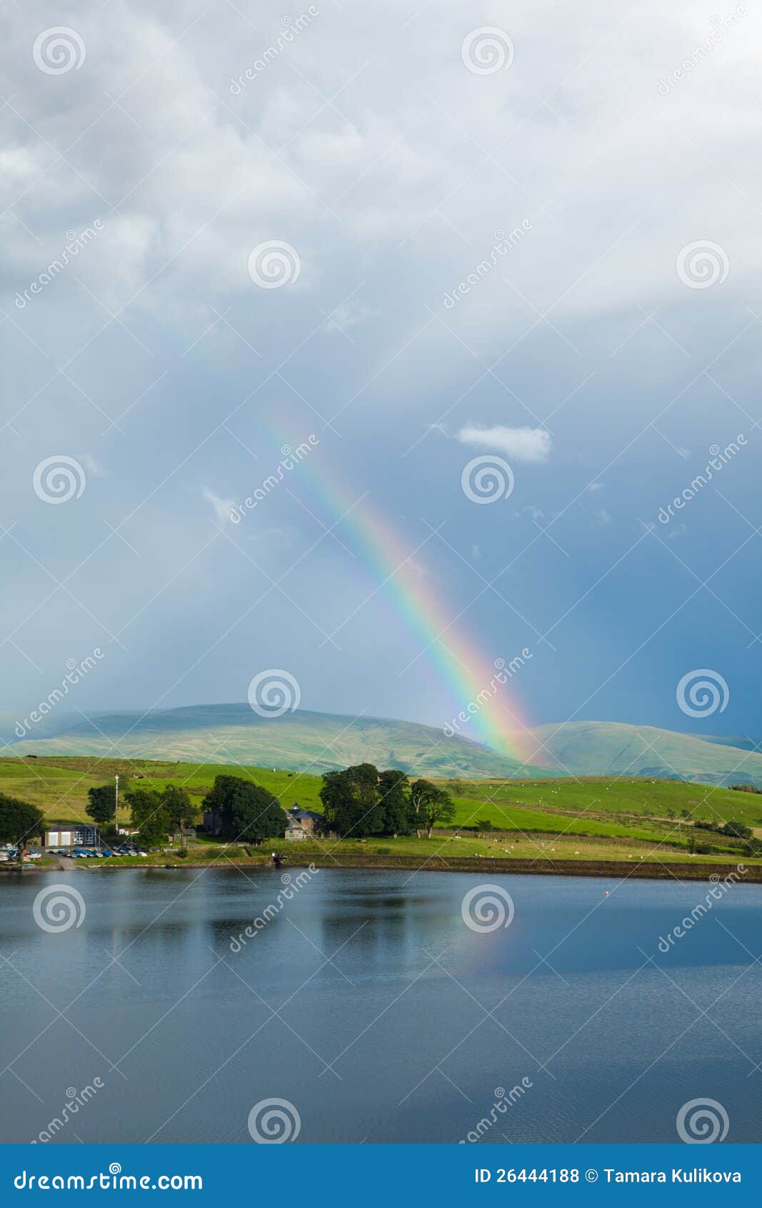 Rainbow over a lake stock photo. Image of boathouse, boats - 26444188