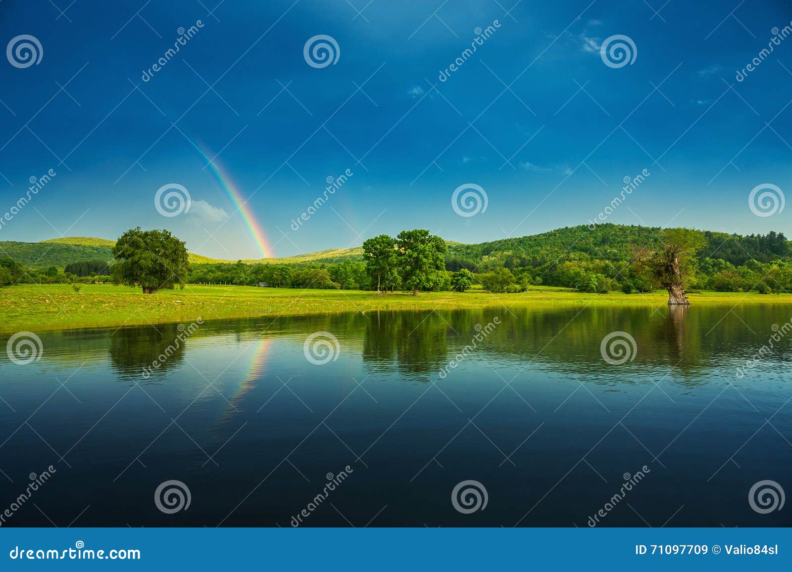 Rainbow Over a Lake, Reflected in the Water Stock Image - Image of ...