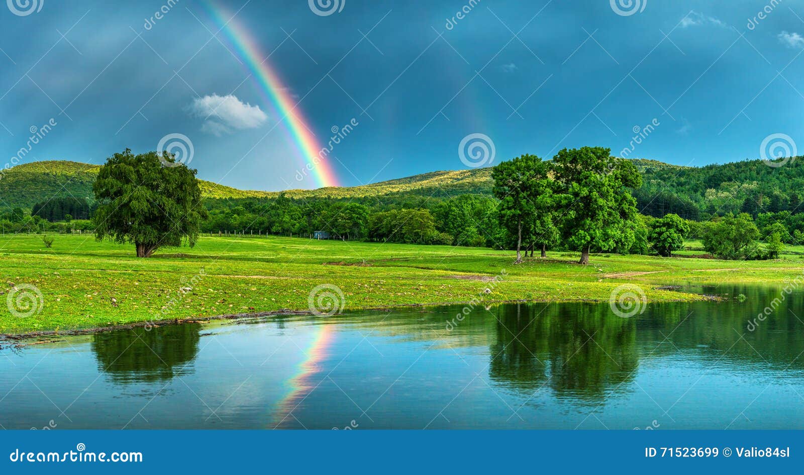 Rainbow Over a Lake, Reflected in the Water Stock Image - Image of ...