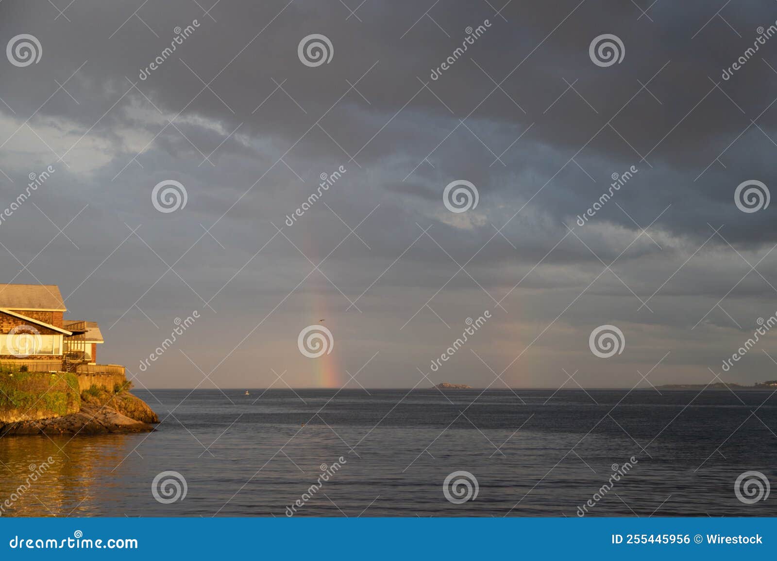 Rainbow Over Ocean at Sunset Stock Photo - Image of stormy, reflection ...