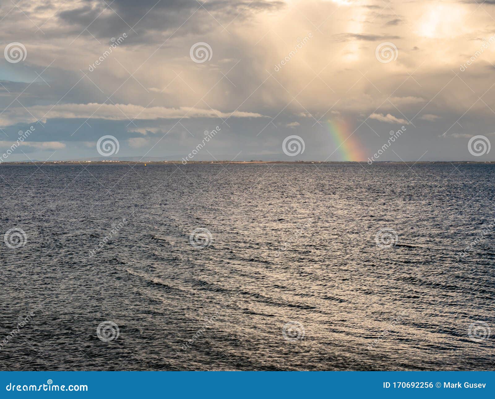 Rainbow Over Ocean Surface, Cloudy Sky, Waves in the Ocean Stock Photo ...