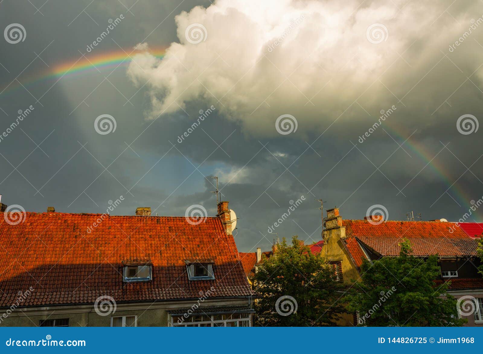 Rainbow Over the Roofs of Houses after the Rain. Stock Image - Image of ...