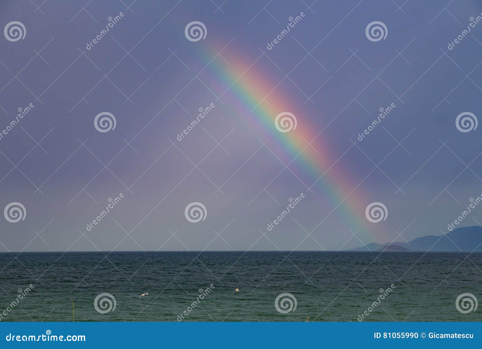 A rainbow over sea stock photo. Image of magic, beach - 81055990